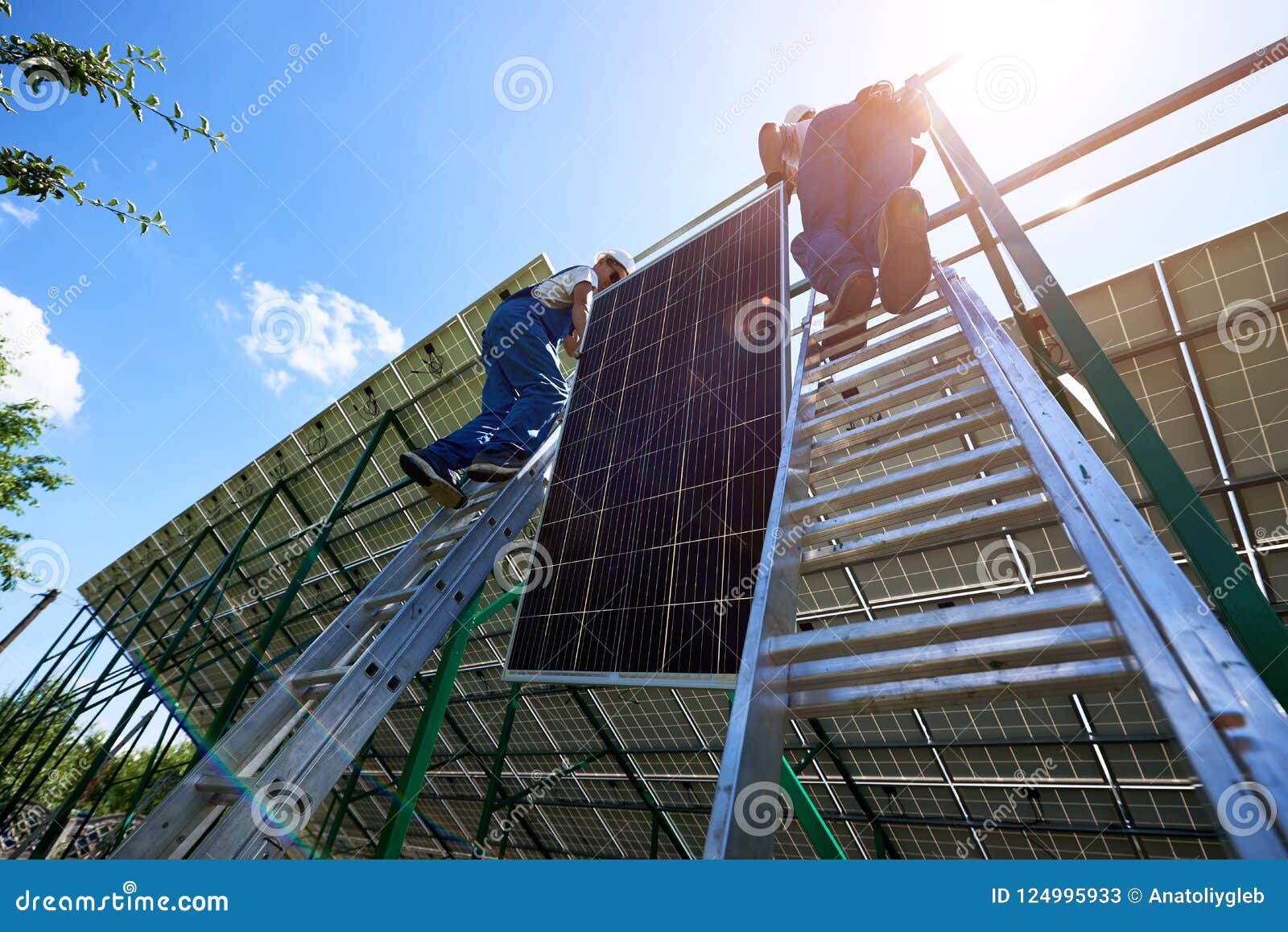 Professional Worker Installing Solar Panels on the Green Metal ...
