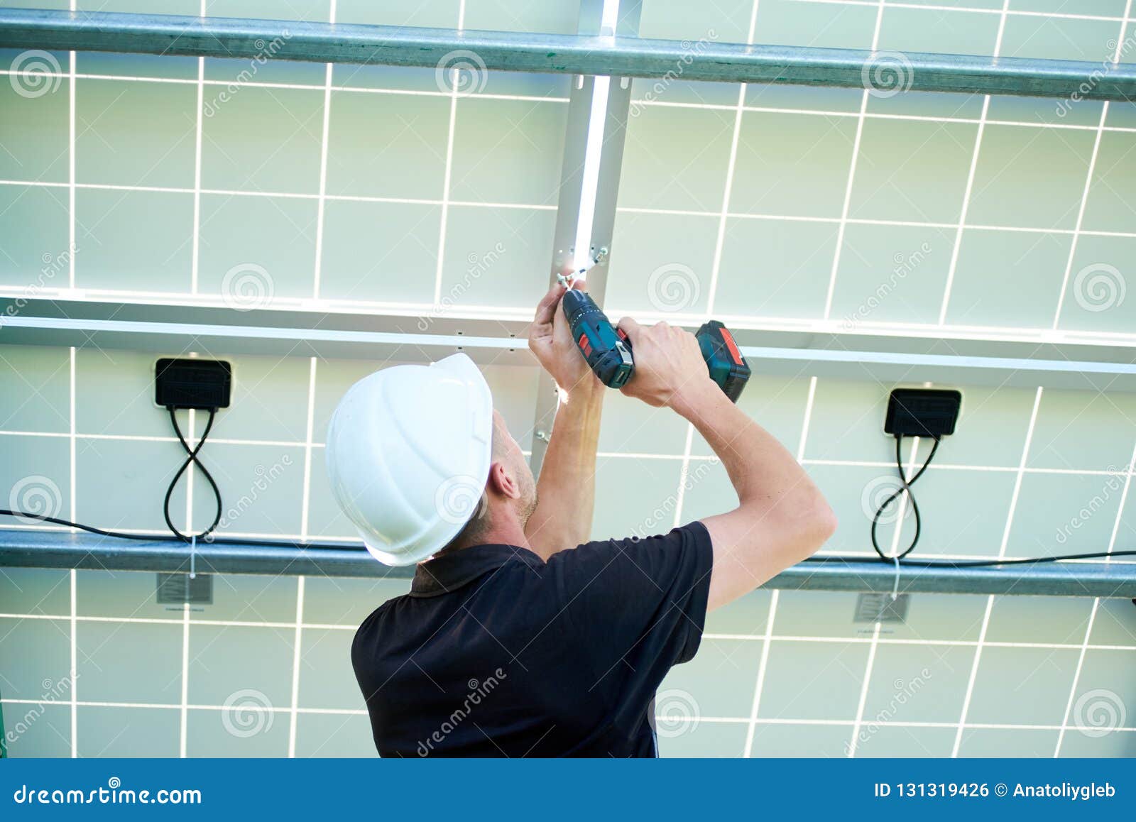 Professional Worker Installing Solar Panels on the Green Metal ...