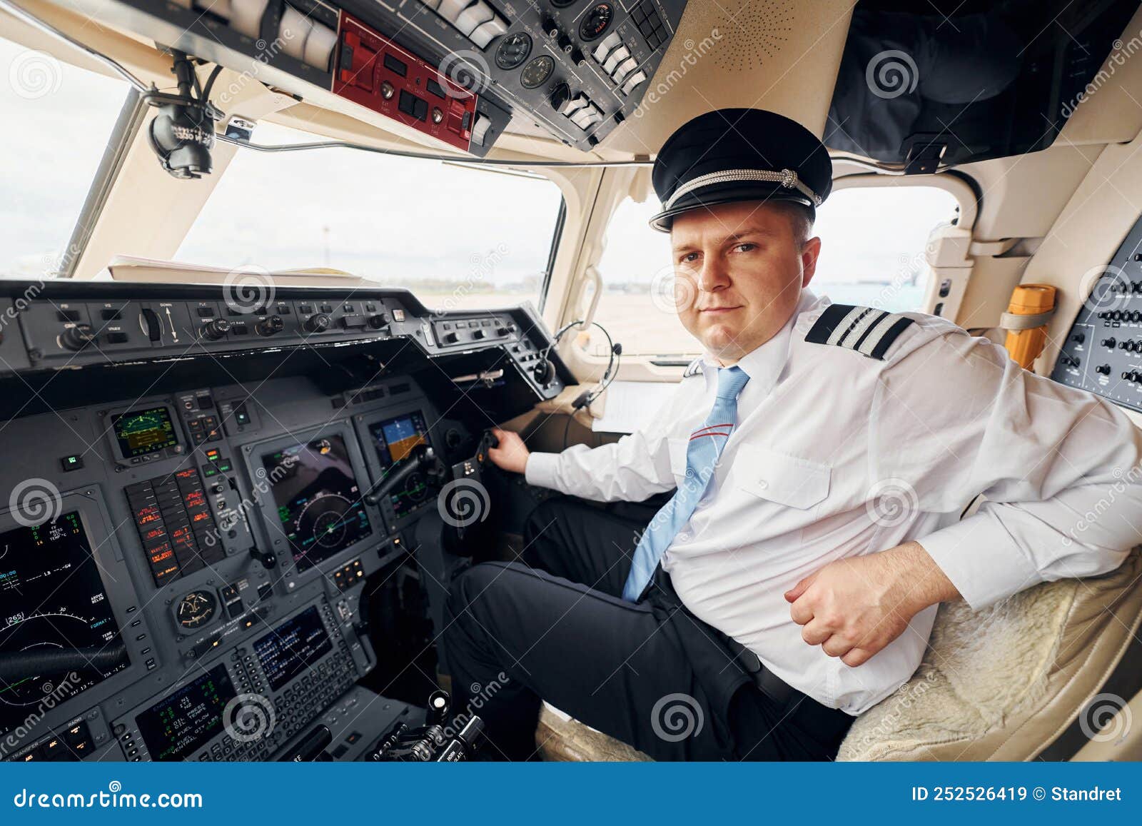 Professional Worker. Pilot in Formal Wear Sits in the Cockpit and ...