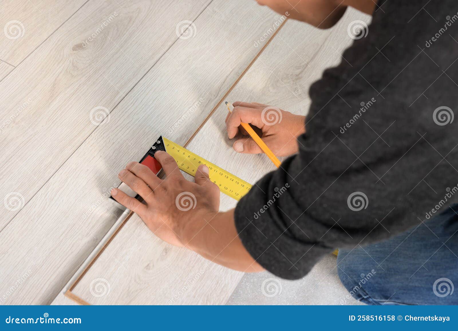 Professional Worker Using Ruler during Installation of Laminate ...