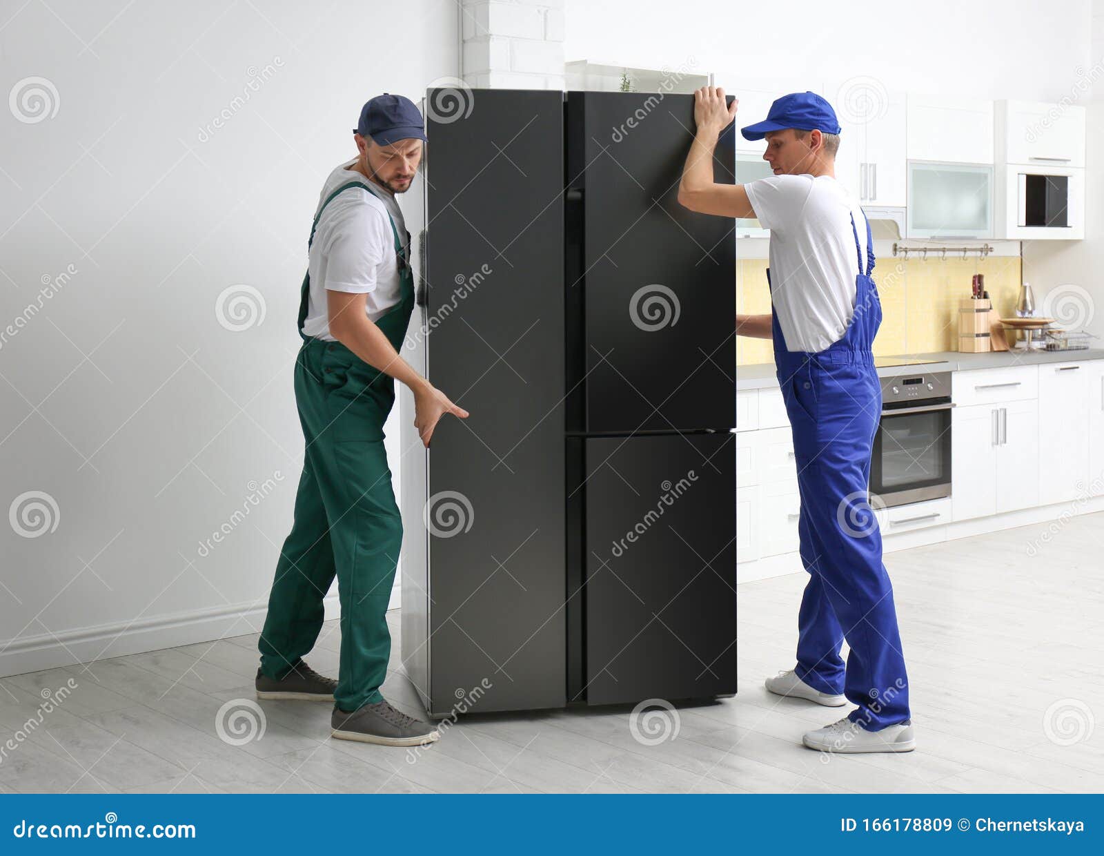 Professional Workers Carrying Modern Refrigerator Stock Image - Image ...