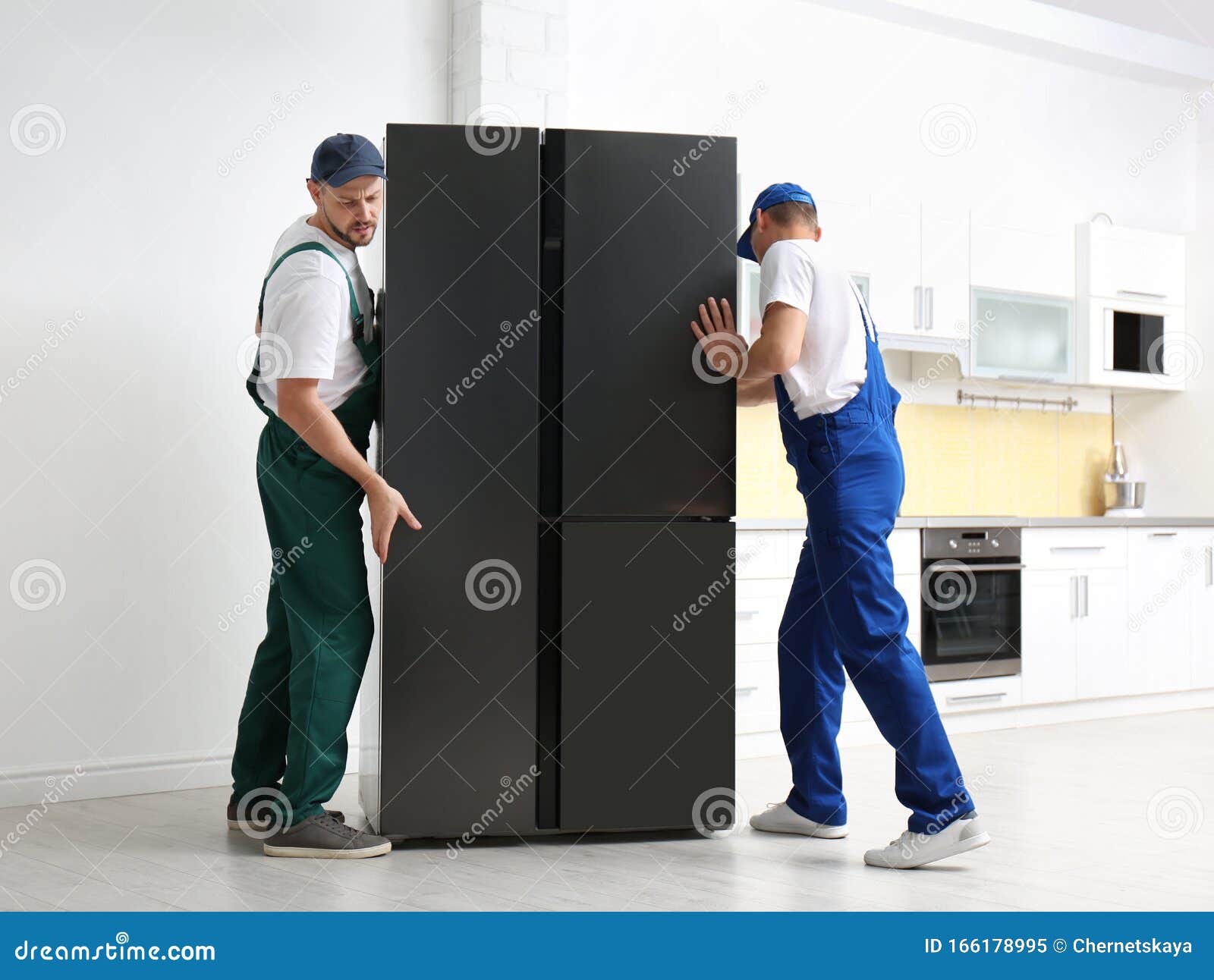 Professional Workers Carrying Modern Refrigerator Stock Image - Image ...