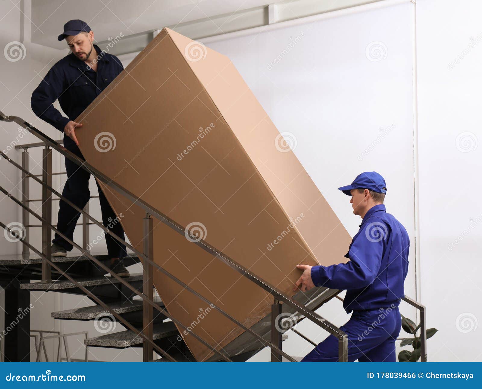 Professional Workers Carrying Refrigerator on Stairs Stock Photo ...