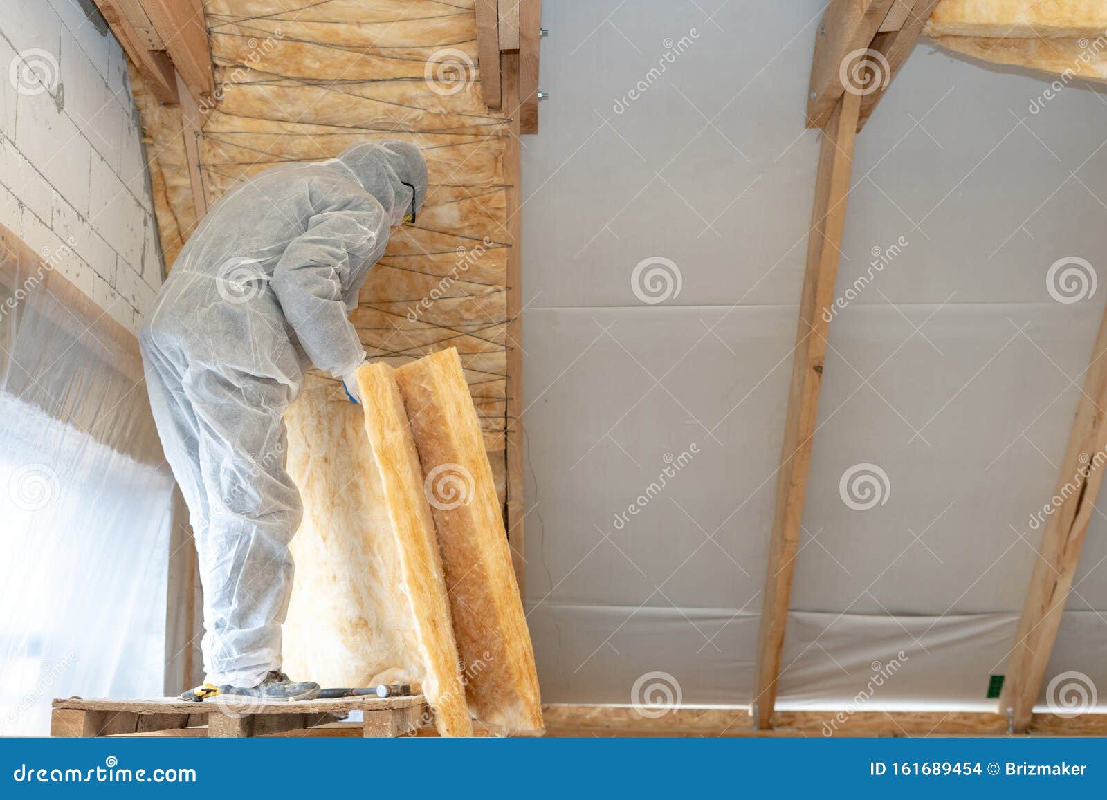 Professional Workman Installing Thermal Insulation Layer with Mineral ...