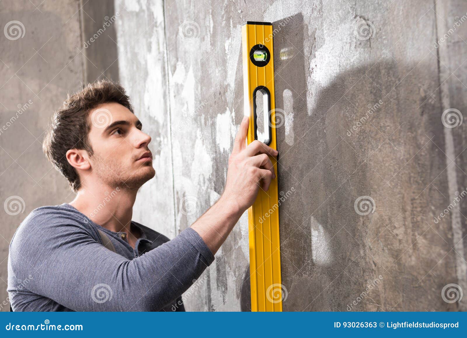 Professional Young Worker Measuring Wall with Level Tool Stock Image ...