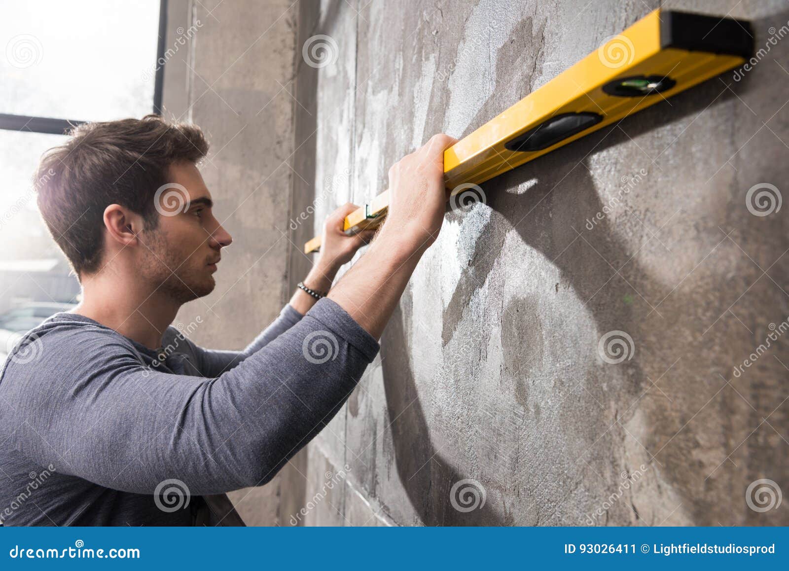 Professional Young Worker Measuring Wall with Level Tool Stock Image ...
