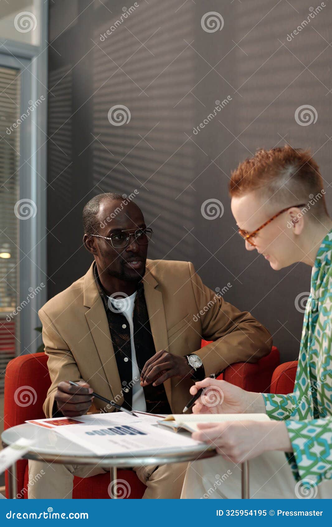 Professionals Reviewing Documents in Modern Office Lounge Stock Image ...