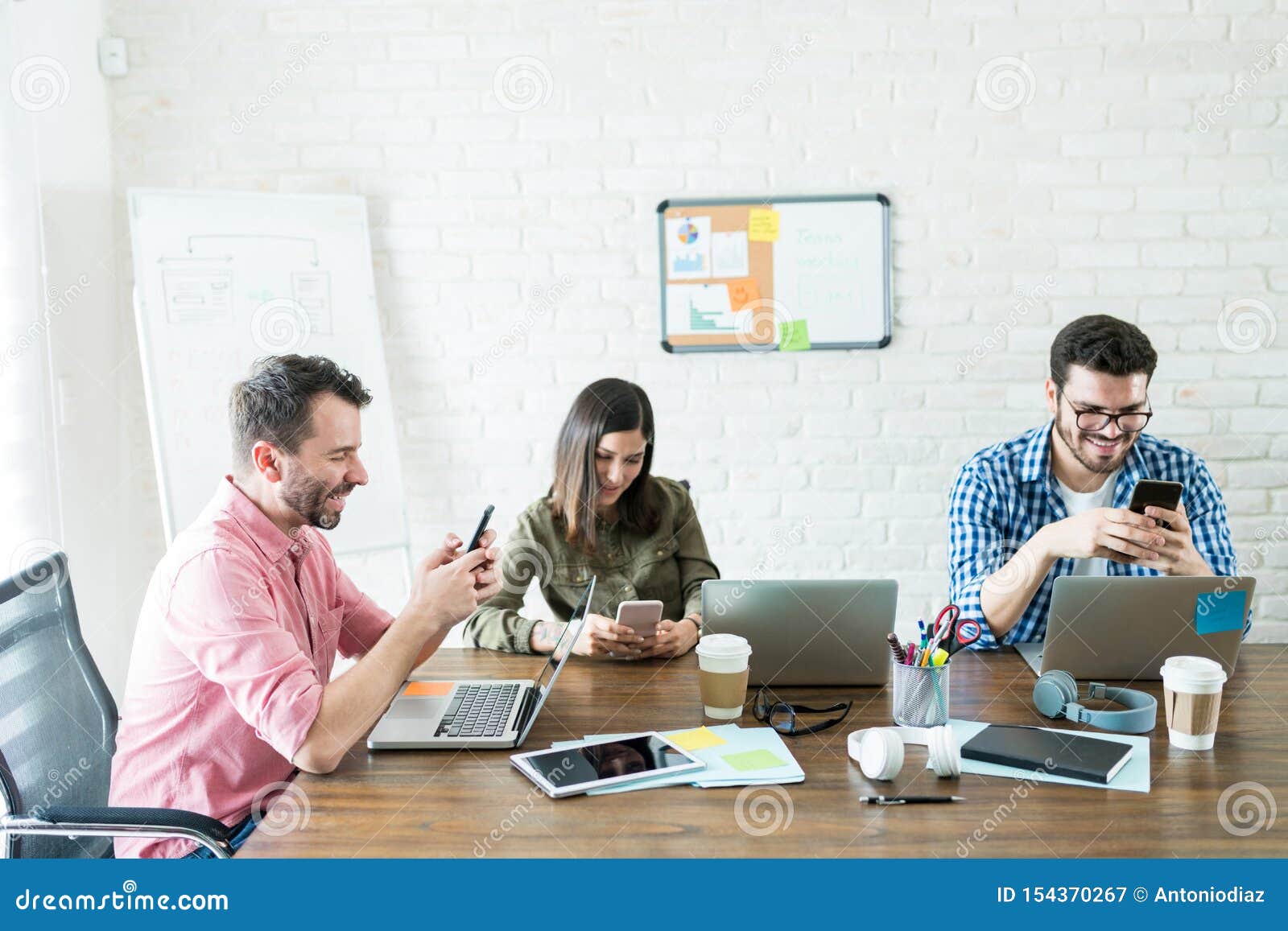 Professionals Socializing while Getting Distracted in Office Stock ...