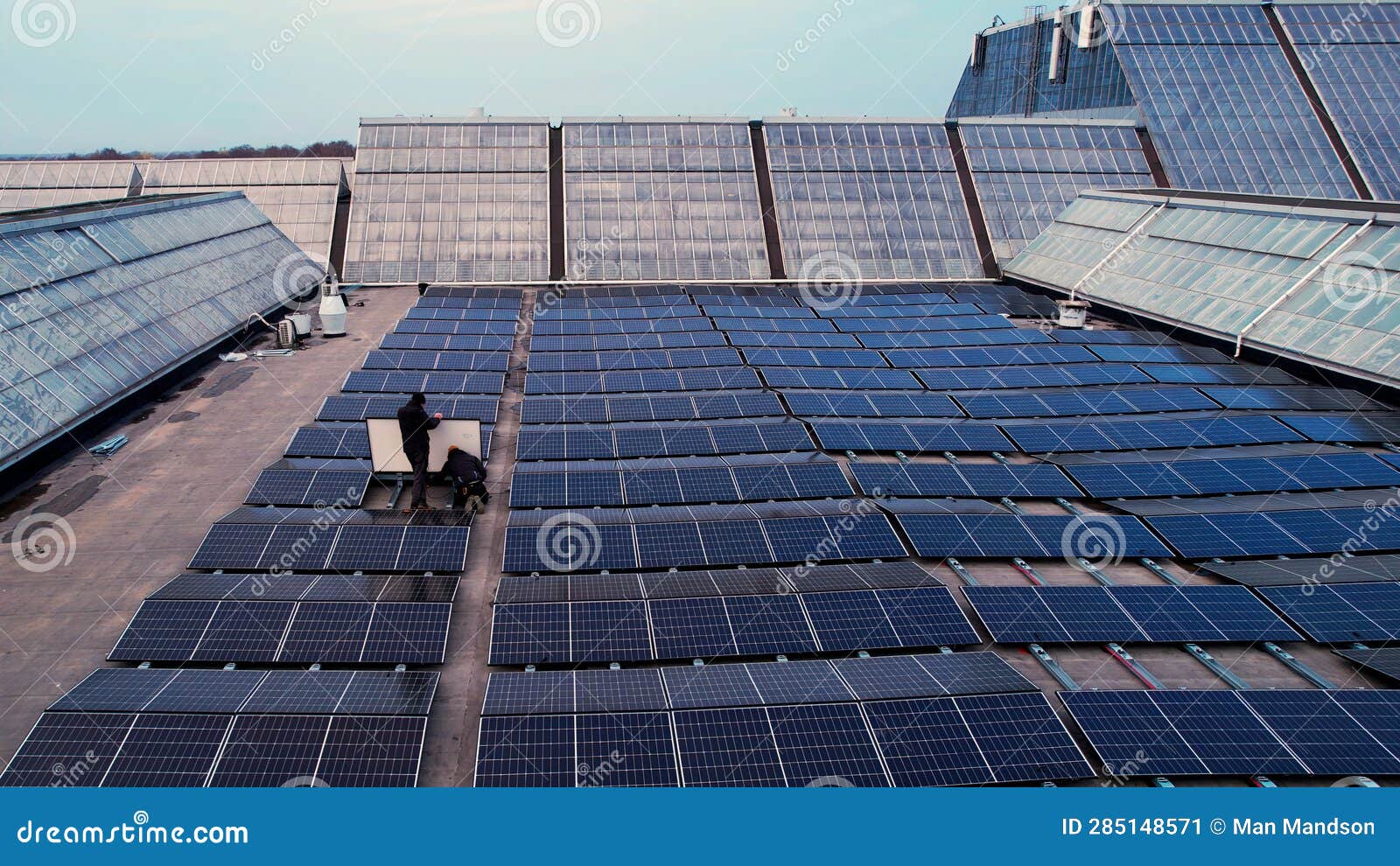 Professionals in Solar Cell Engineering Engaged on Roof Solar Panel ...