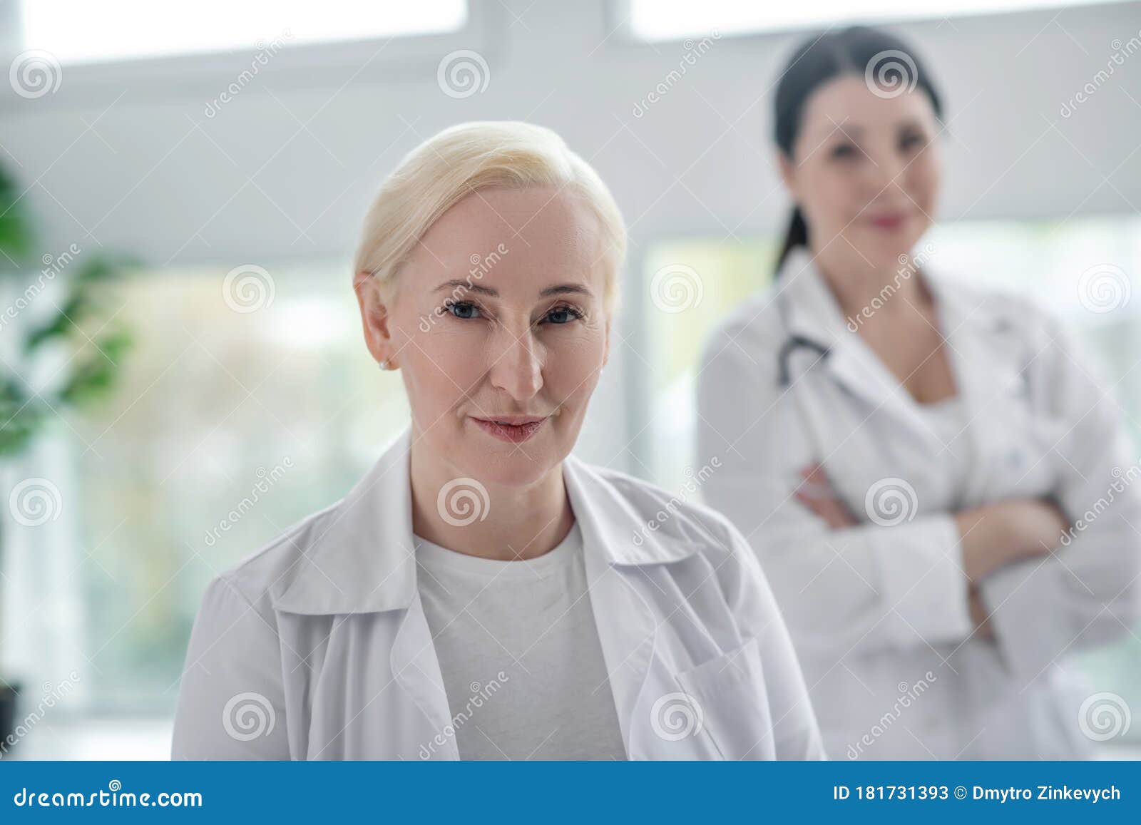 Two Doctors in White Robes Looking Determined Stock Image - Image of ...