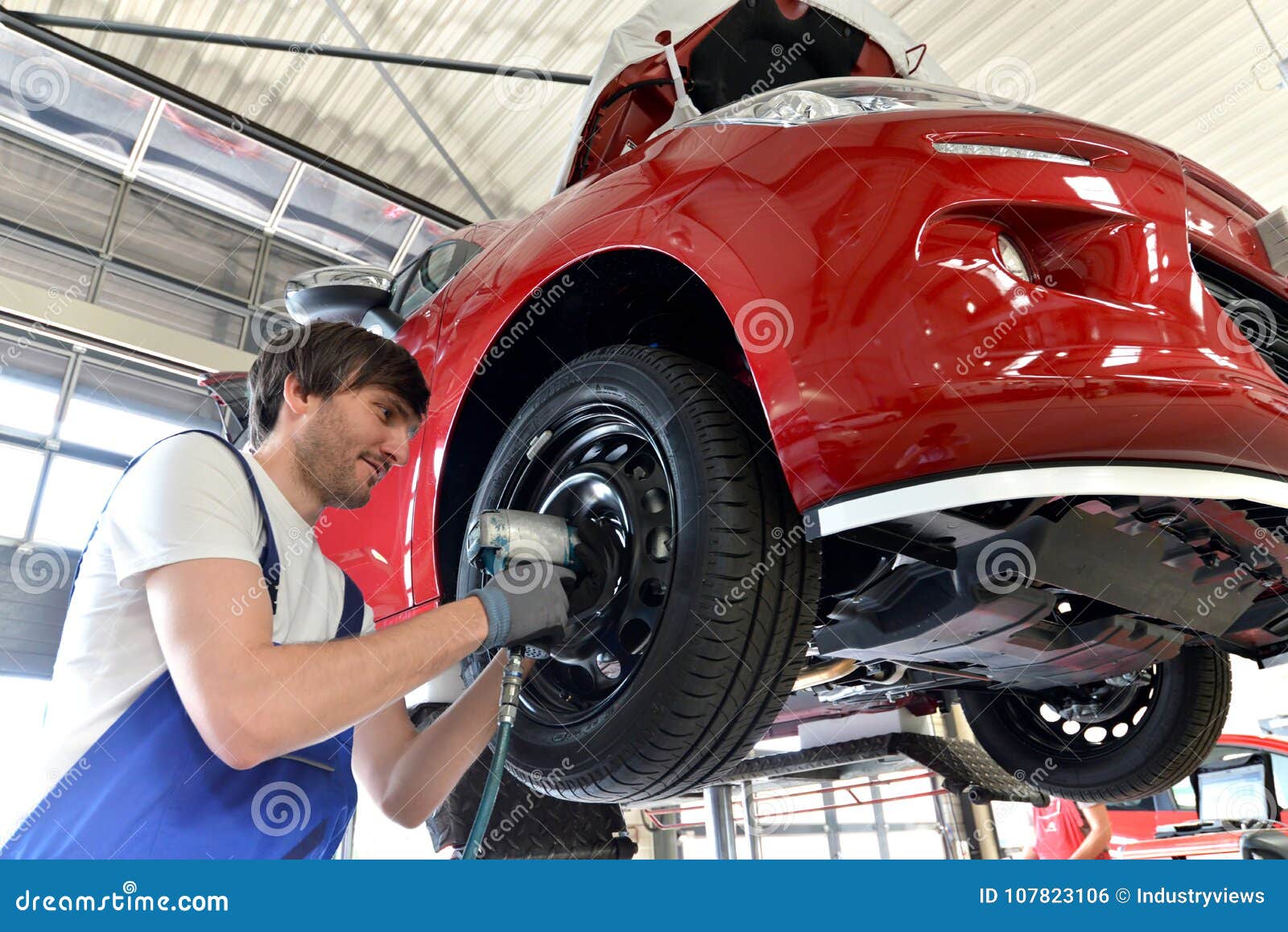 Tyre Change on the Car by Mechanics in a Workshop Stock Photo - Image ...