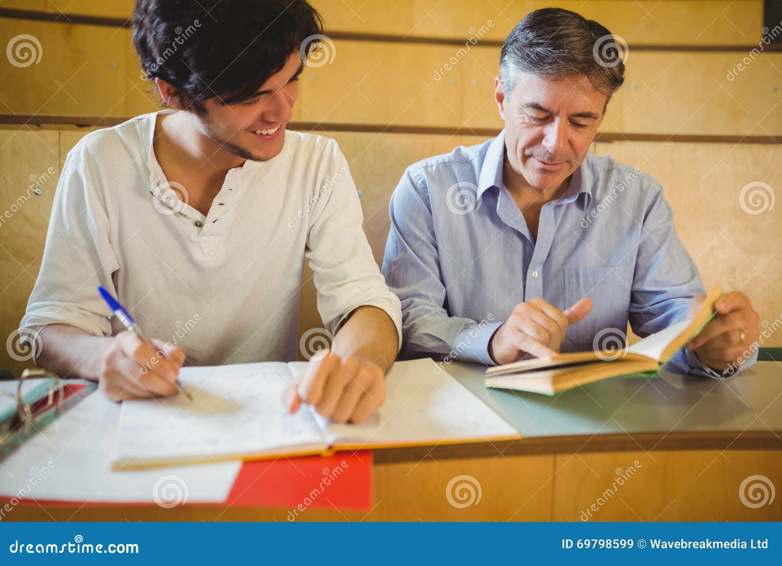 Professor Assisting a Student with His Study Stock Image - Image of ...