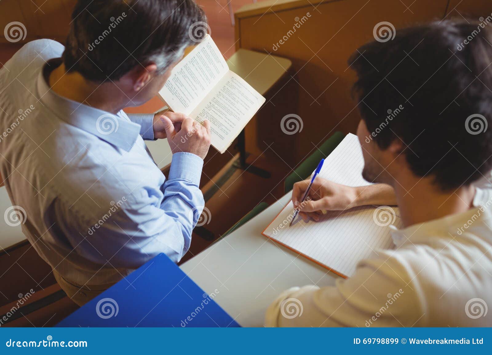 Professor Assisting a Student with His Study Stock Image - Image of ...