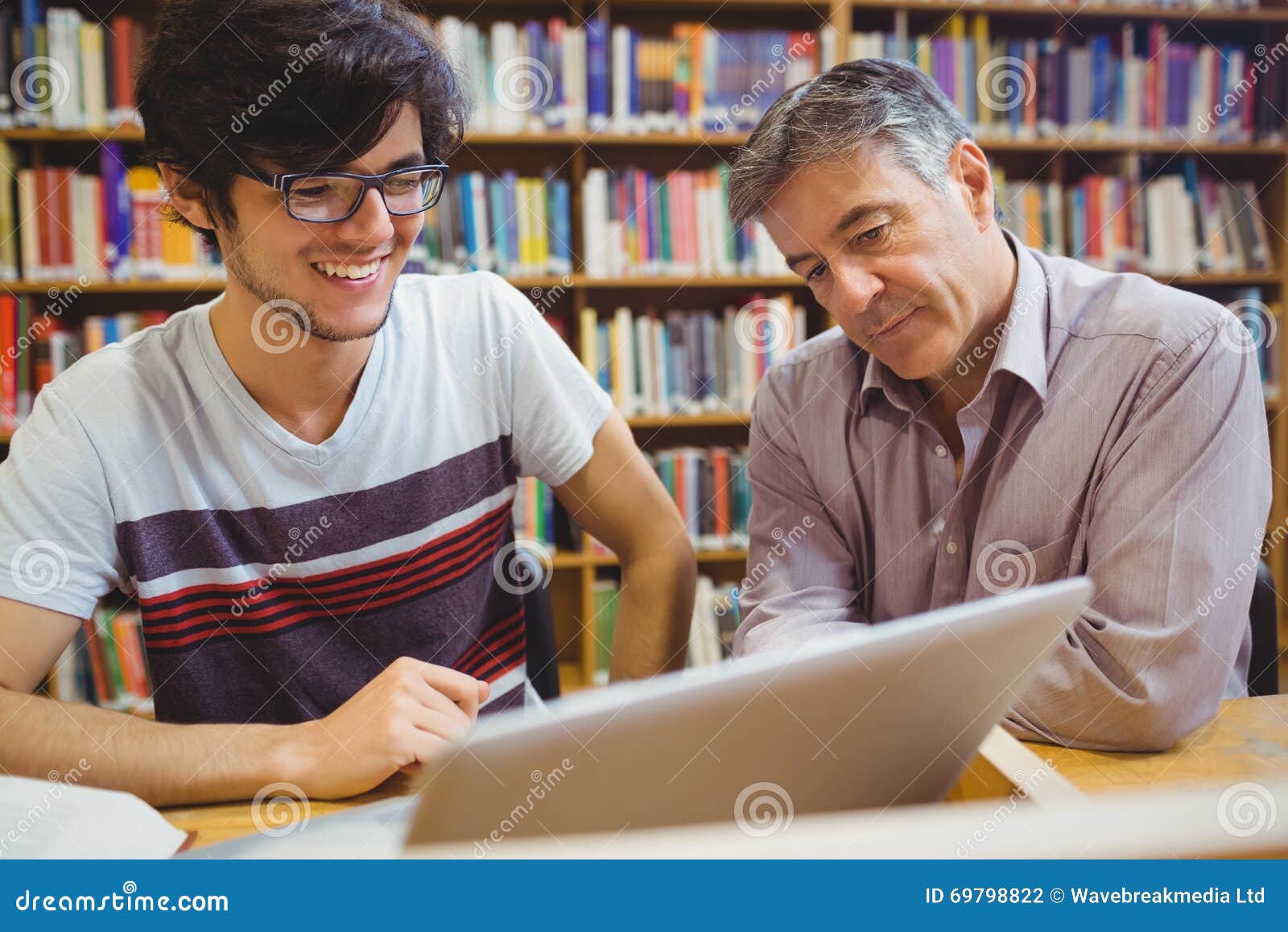 Professor Assisting a Student with Studies Stock Photo - Image of ...