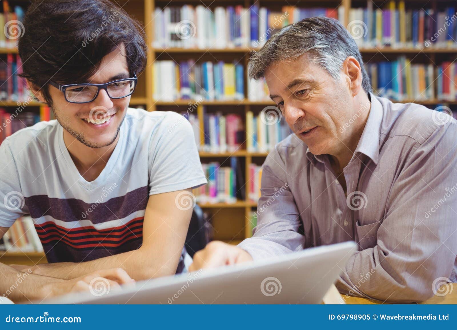 Professor Assisting a Student with Studies Stock Image - Image of ...
