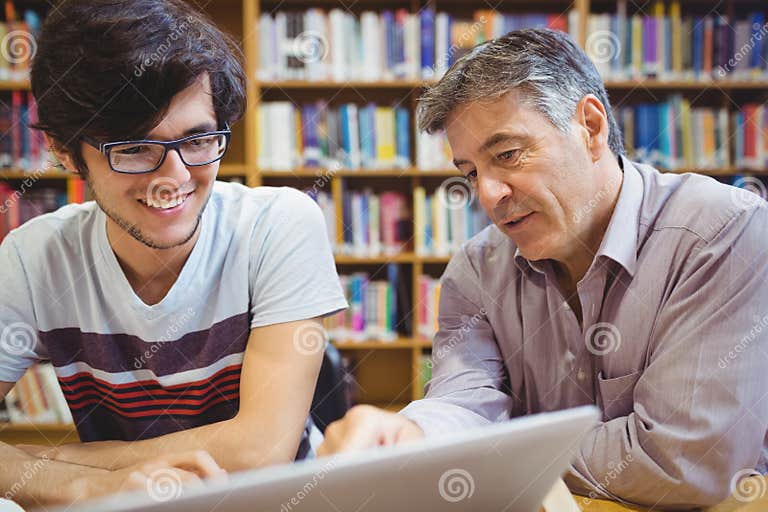 Professor Assisting a Student with Studies Stock Image - Image of ...