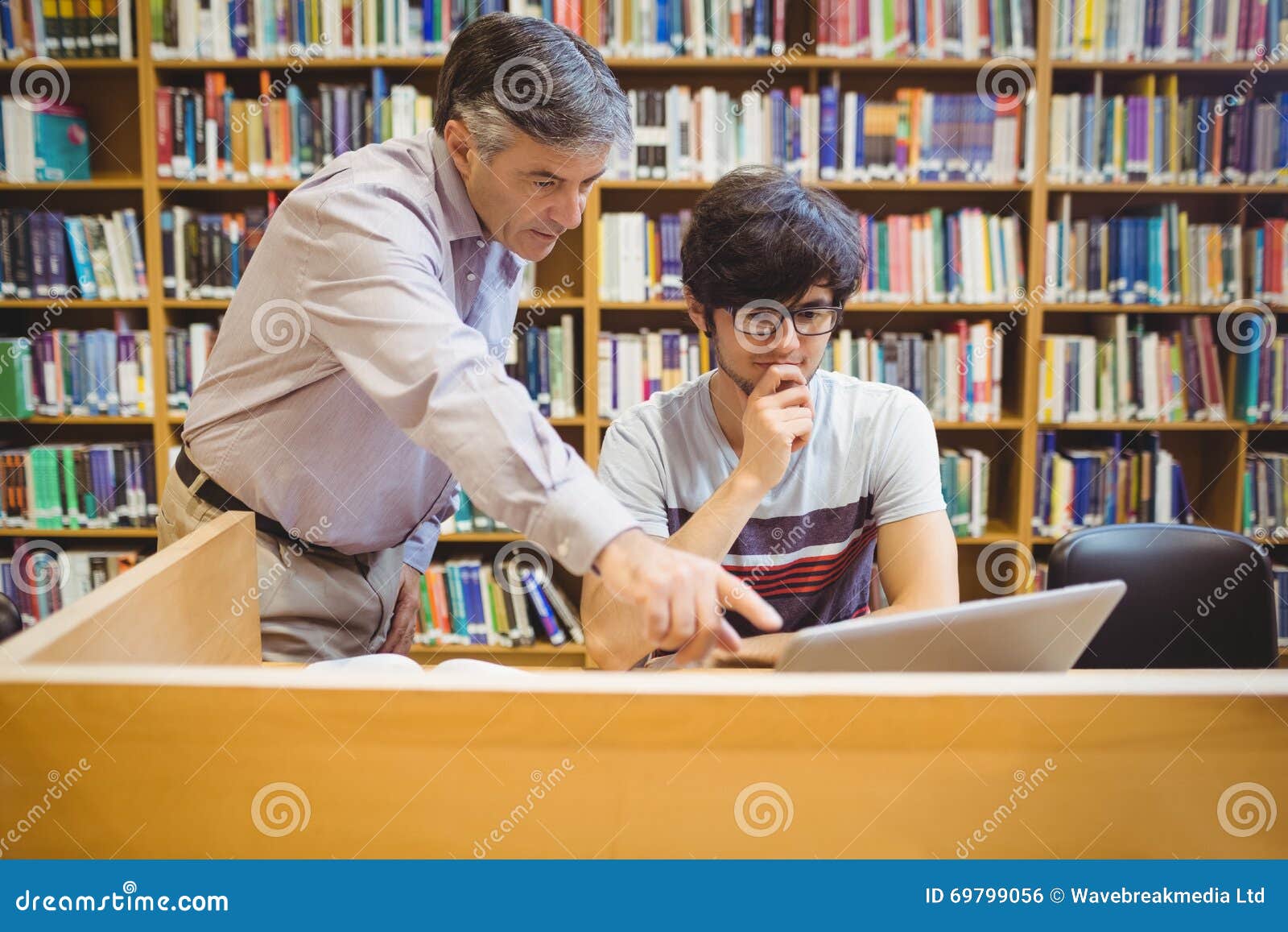 Professor Assisting a Student with Studies Stock Photo - Image of ...