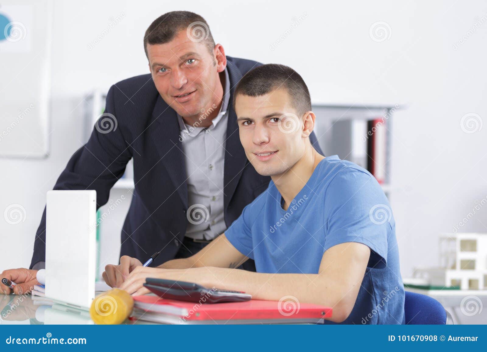 Professor Assisting Student with Studies in College Library Stock Photo ...