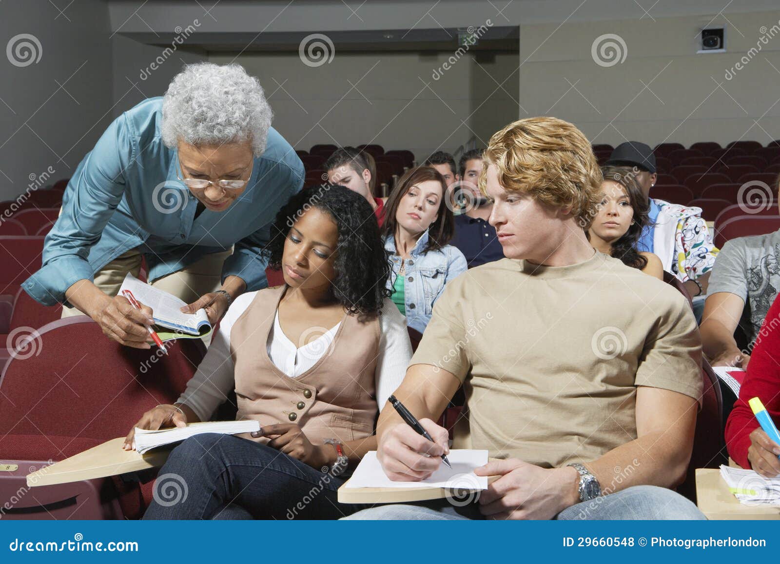 Professor Assisting Students in Class Stock Photo - Image of adult ...