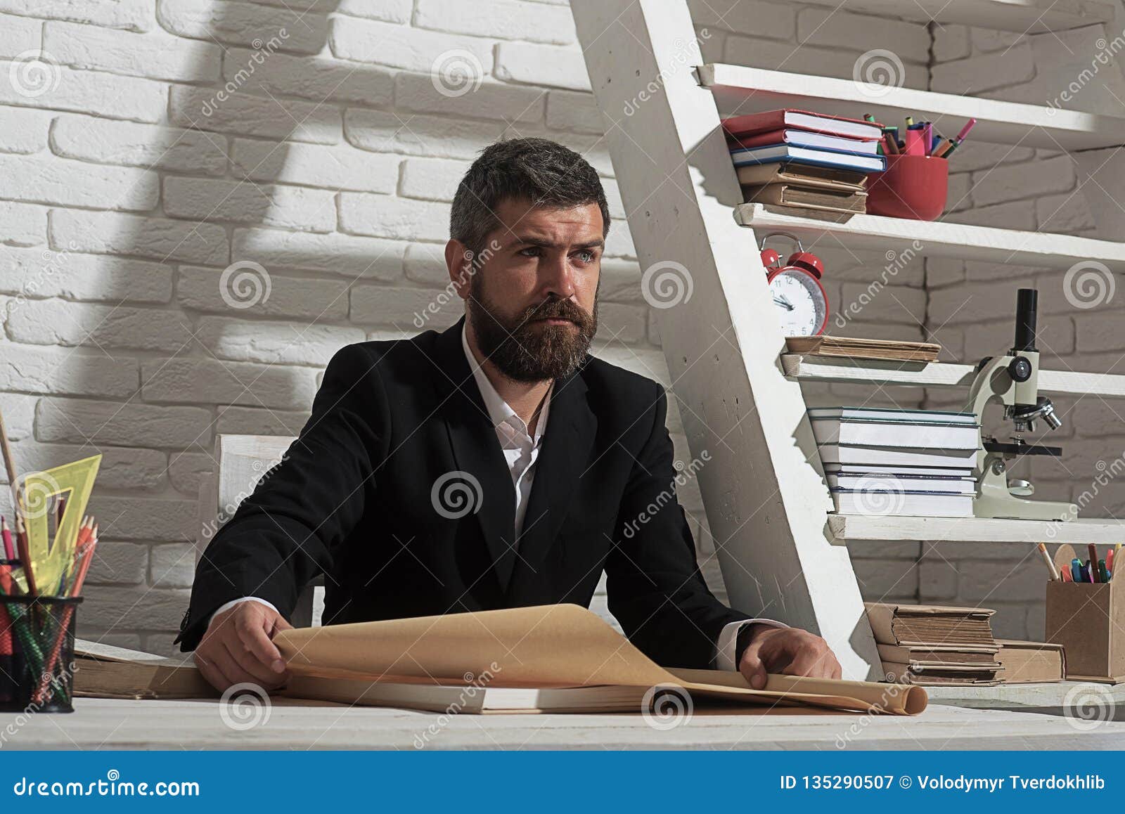 Professor with Confident Face Expression Sits at Desk Stock Image ...