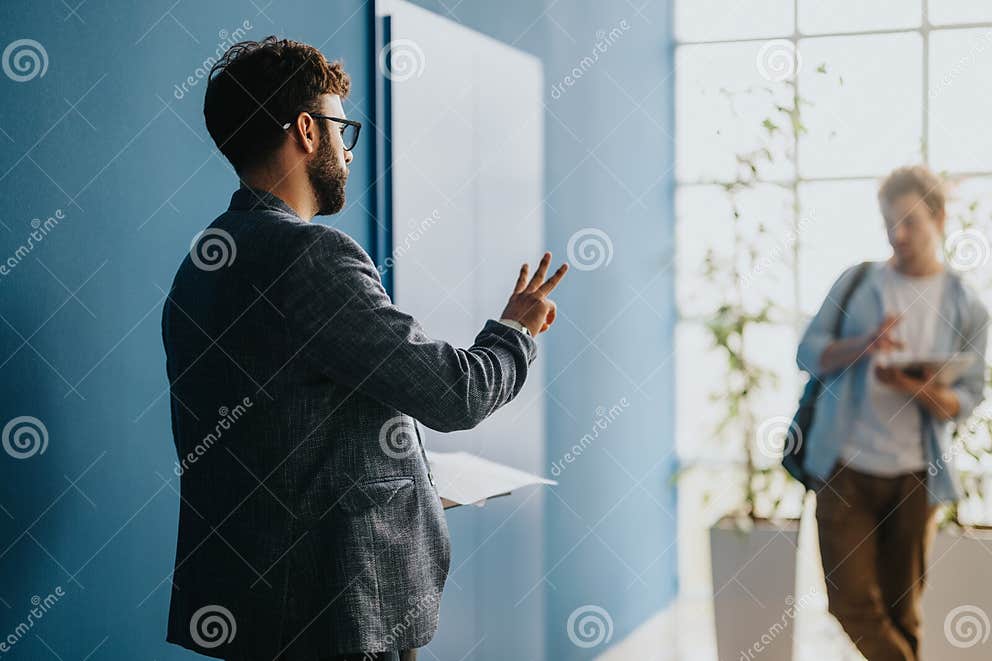 Professor Discussing with Students between Classes in Modern Hallway ...