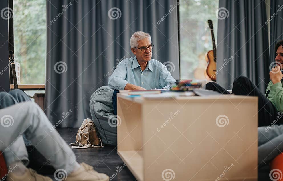 Professor Engaging with Students in a Relaxed Classroom Setting Stock ...