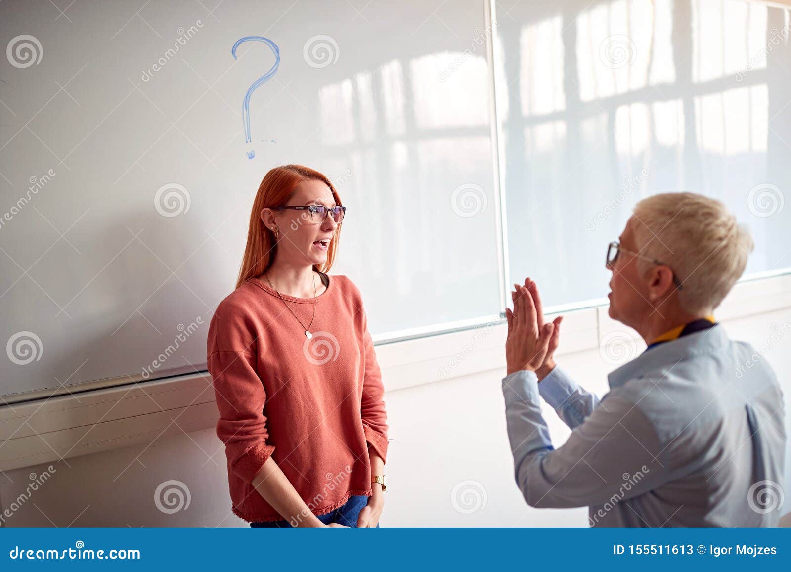 Professor Explaining and Questioning Student in Classroom on Board ...