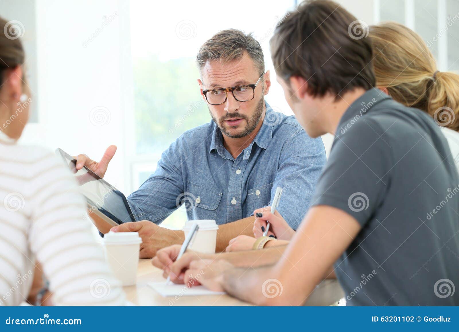 Professor Explaining Subject To Students with Tablet Stock Photo ...