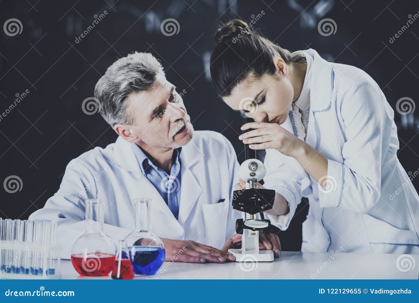 Professor Explains Student about Using Microscope. Stock Image - Image ...
