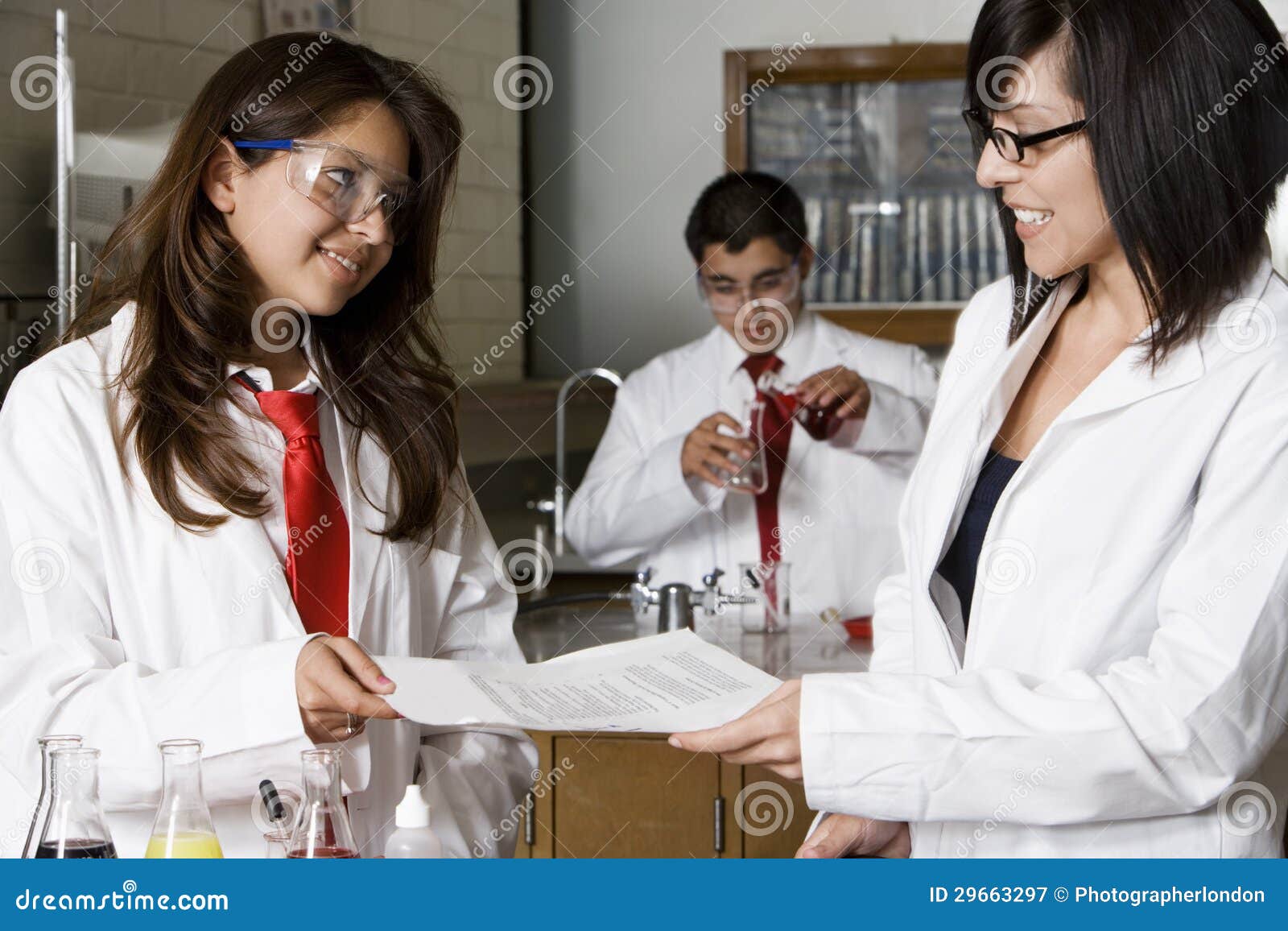 Professor Handing Over Document To Female Student Stock Image - Image ...