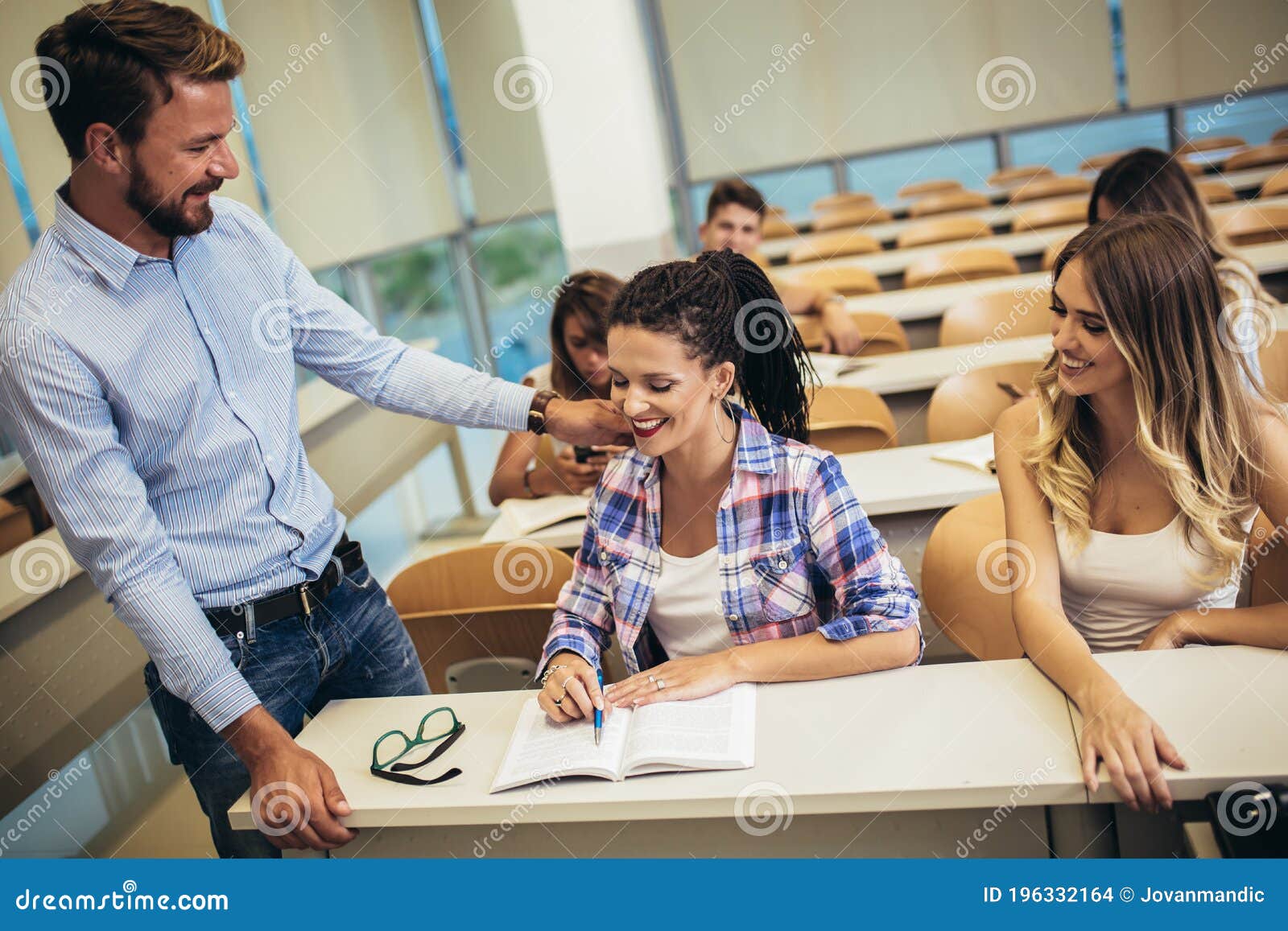 Professor Helping a Student in Classroom Stock Photo - Image of listen ...