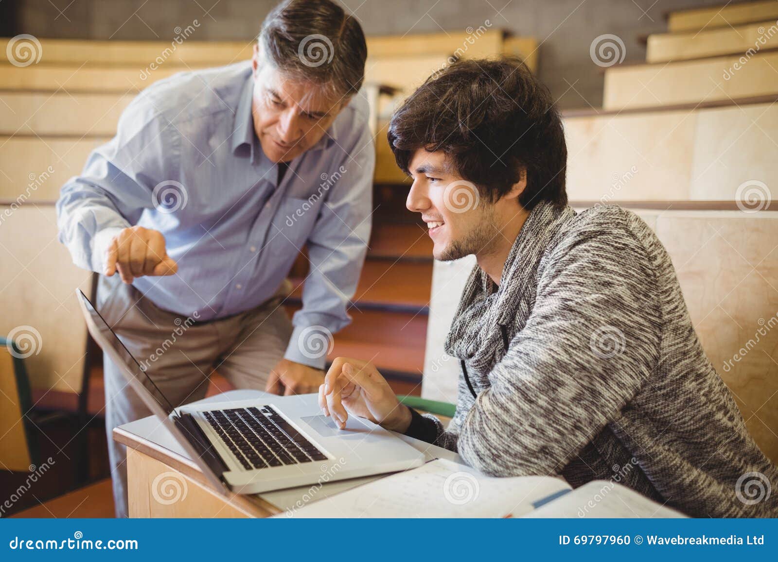 Professor Helping a Student in Classroom Stock Photo - Image of ...