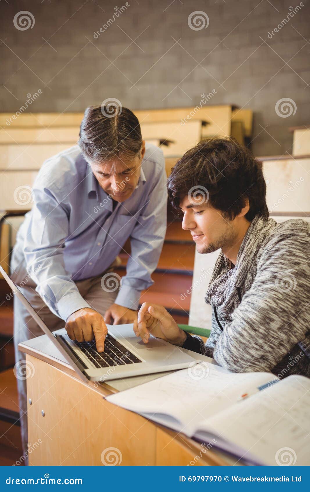 Professor Helping a Student in Classroom Stock Photo - Image of ...