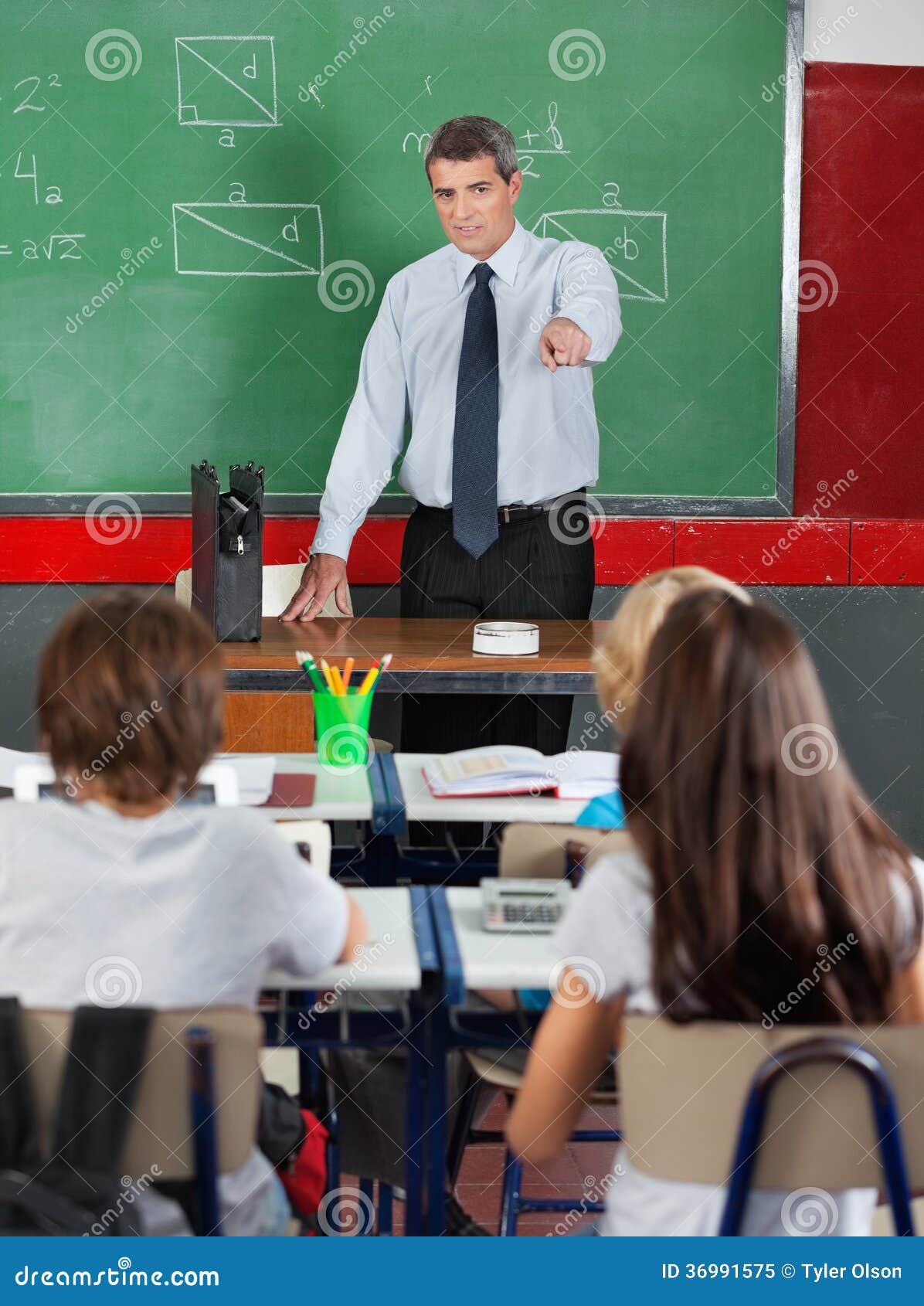 Professor Pointing at Students Na Sala De Aula Imagem de Stock - Imagem ...
