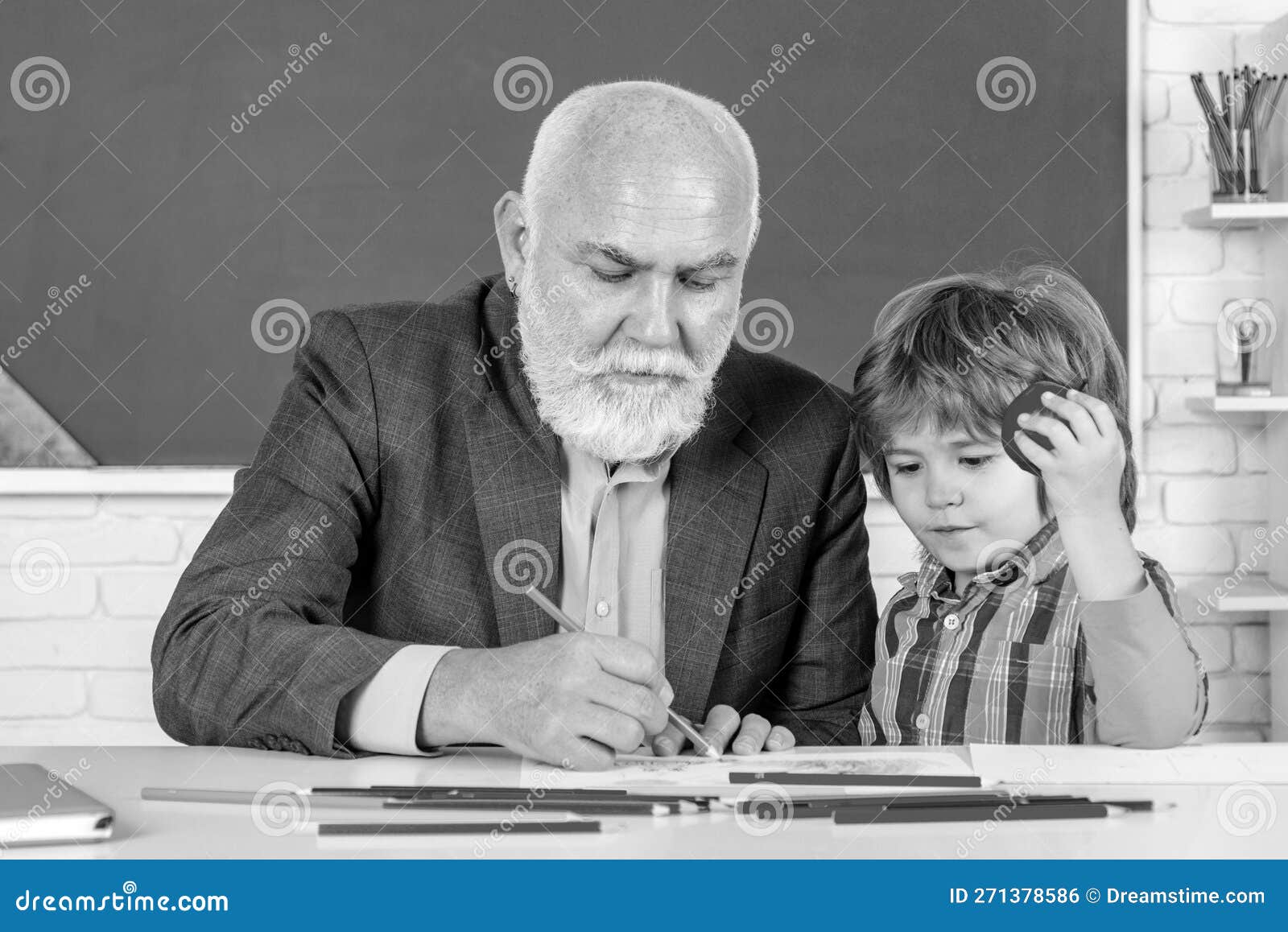 Professor and Pupil in Classroom at the Elementary School. Child at ...