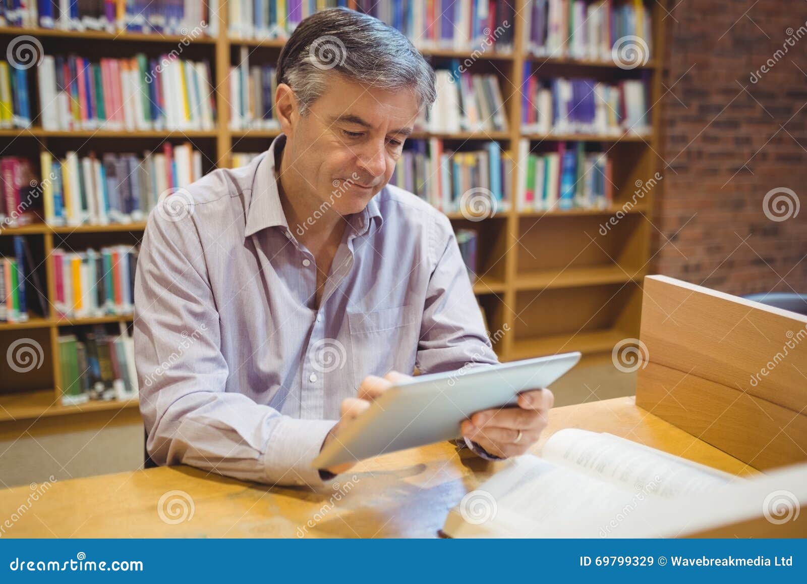 Professor Sitting at Desk Using Digital Tablet Stock Image - Image of ...