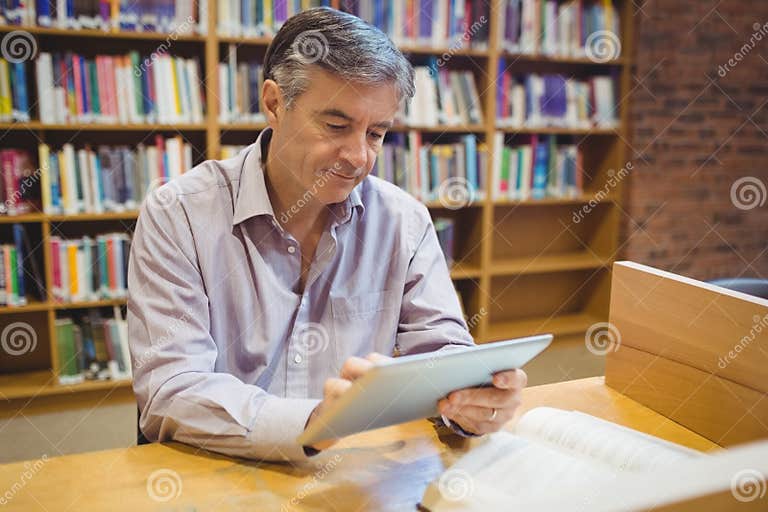Professor Sitting at Desk Using Digital Tablet Stock Image - Image of ...