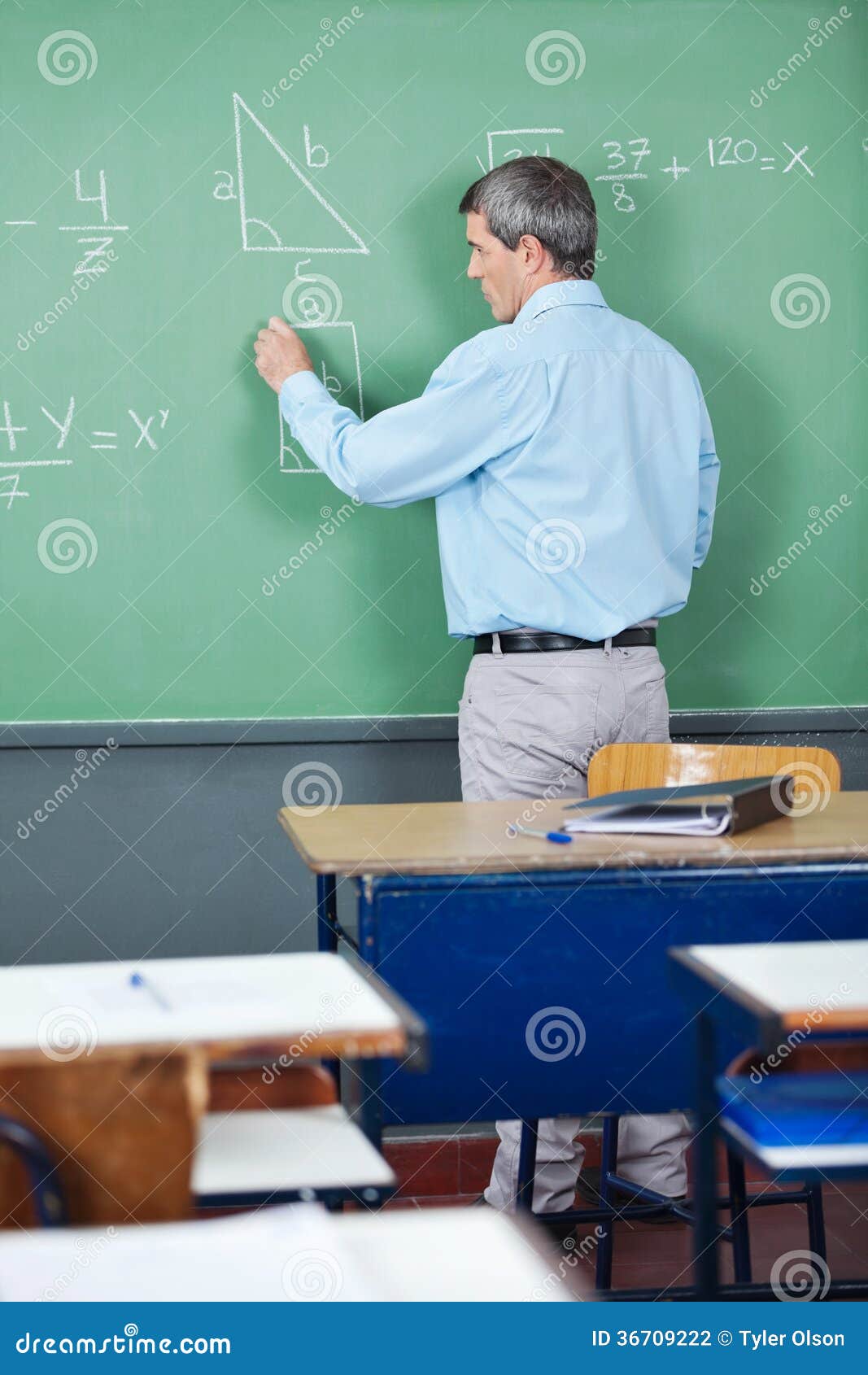 Professor Solving Mathematics on Greenboard in Stock Photo - Image of ...