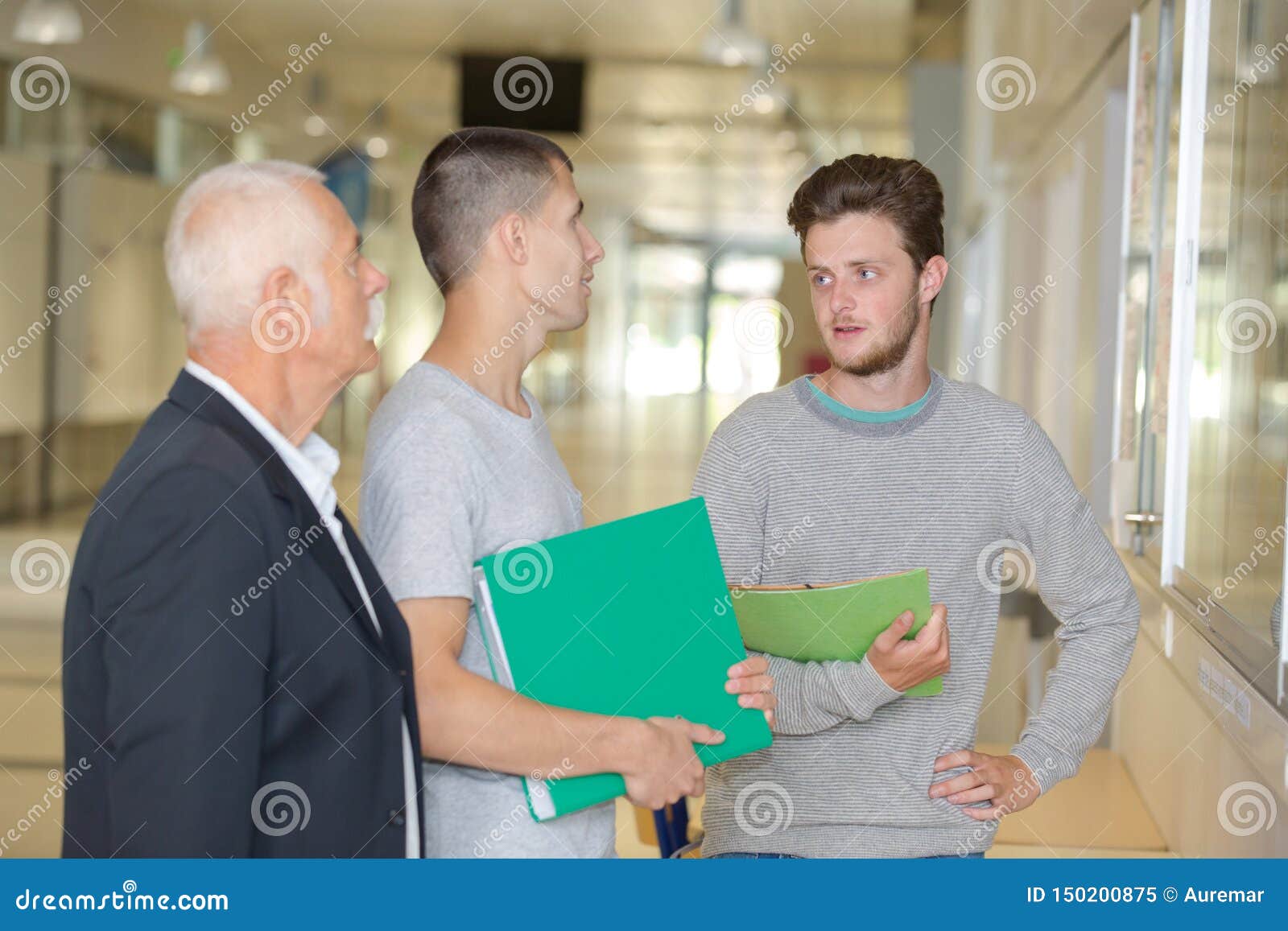 Professor Talking To Students in Corridor Stock Image - Image of ...