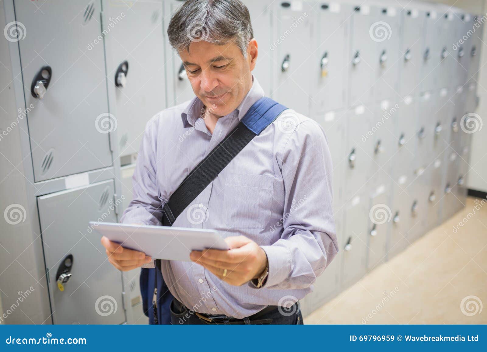 Professor Using Digital Tablet in Locker Room Stock Image - Image of ...