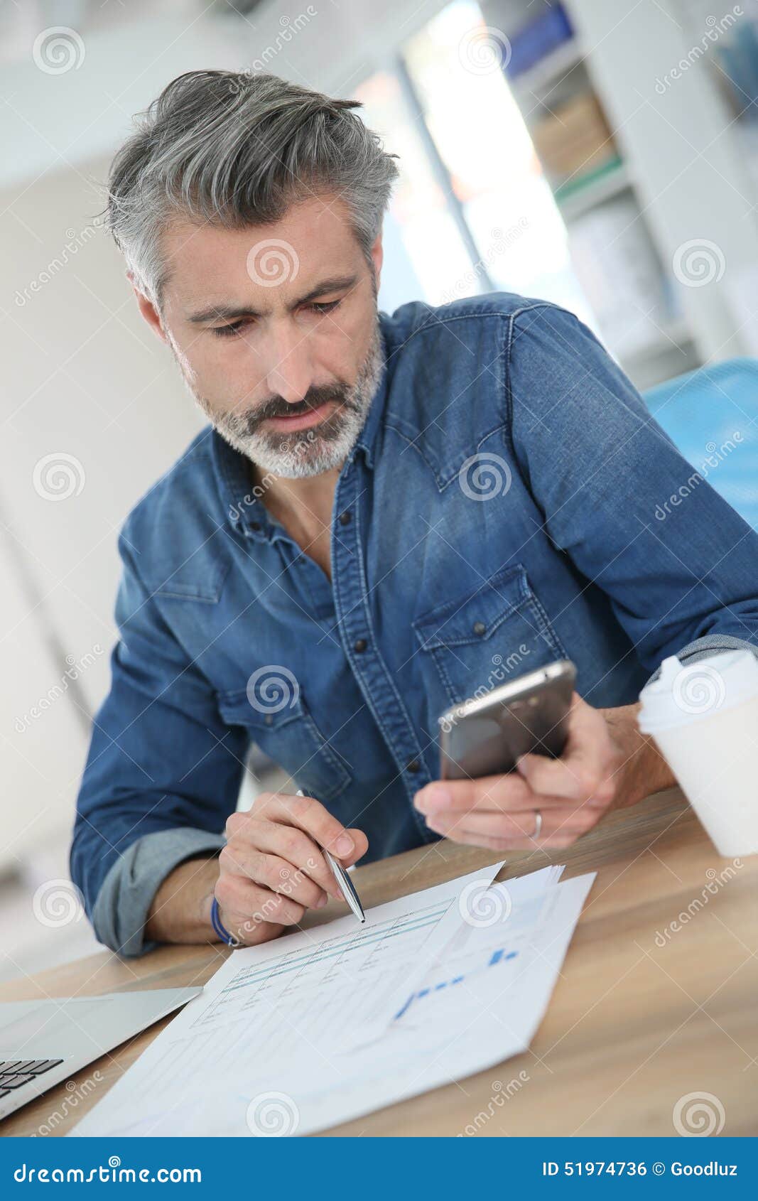 Professor Using Laptop and Smartphone in School Office Stock Photo ...