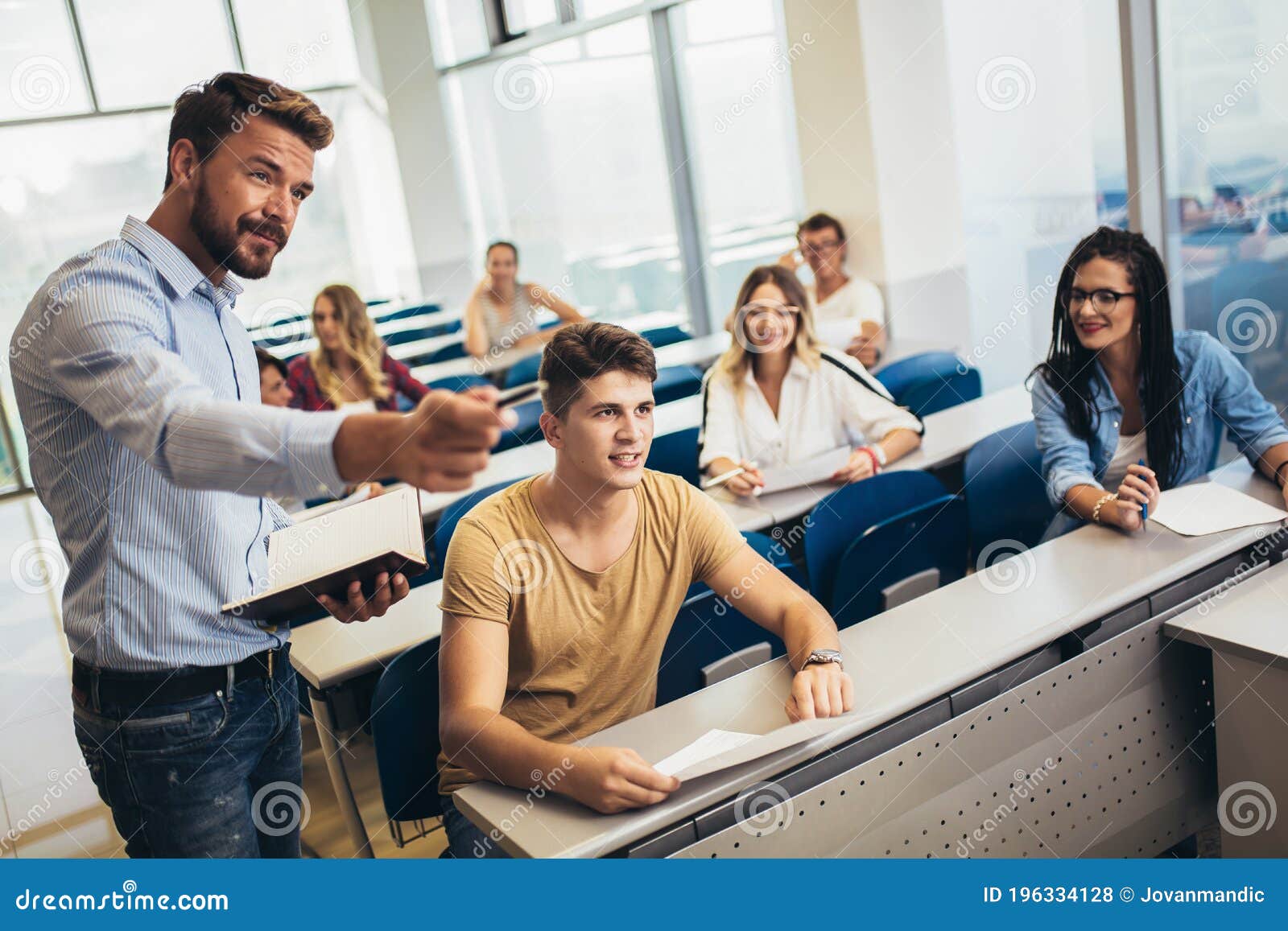 Proffesor Giving Presentation in Lecture Hall at University Stock Photo ...