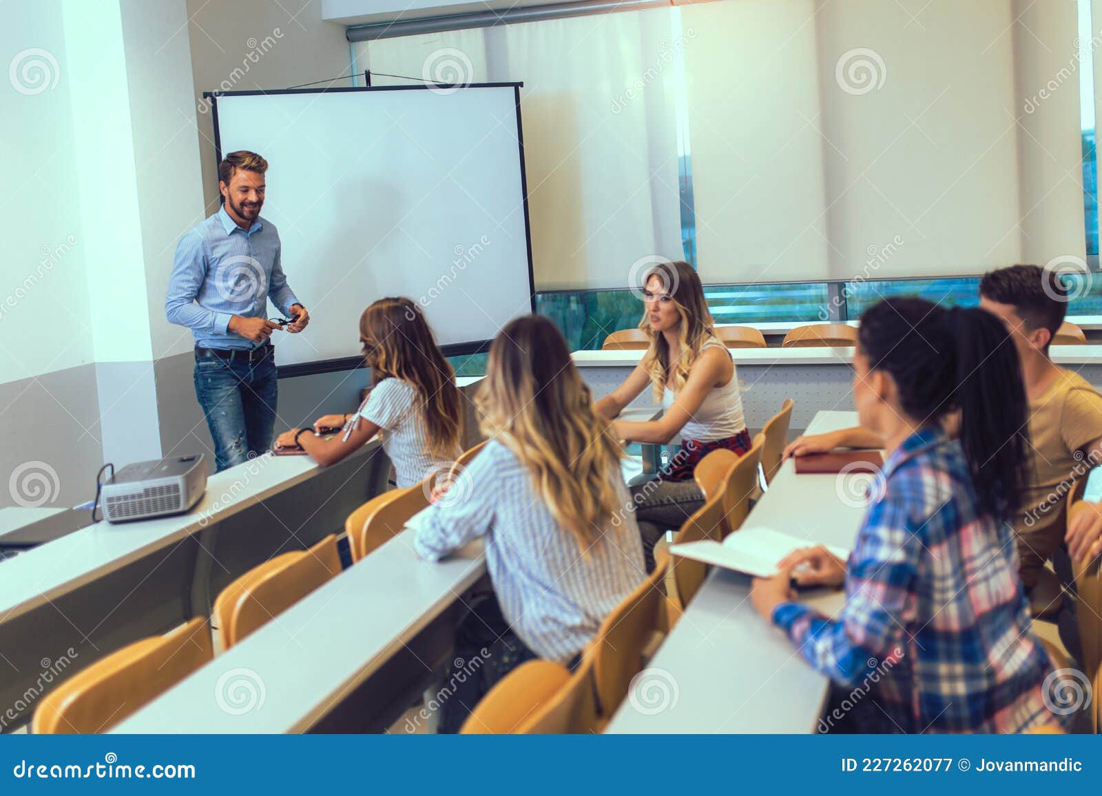 Proffesor Giving Presentation in Lecture Hall at University Workshop ...
