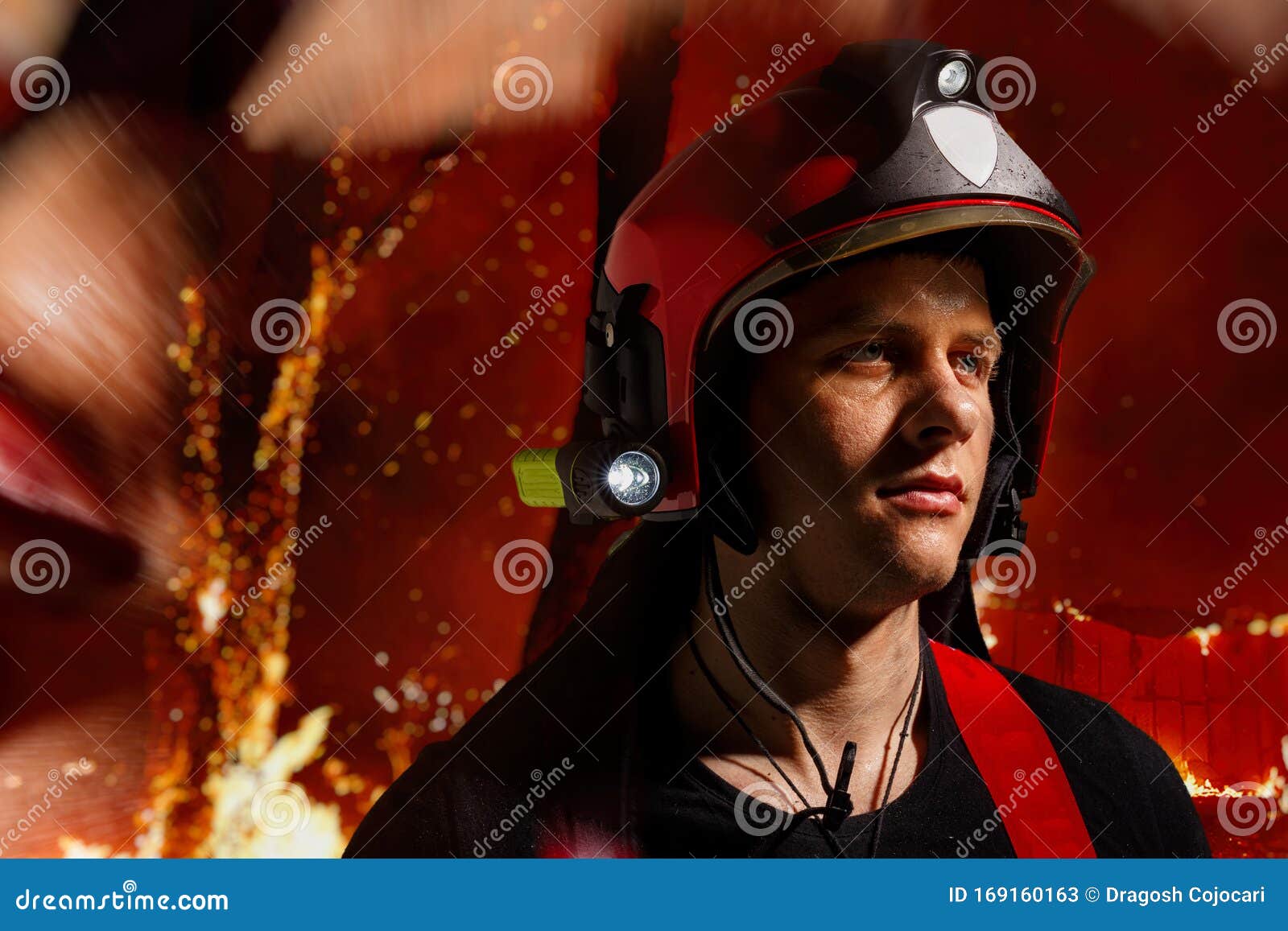 Profile of a Firefighter Equipped in a Helmet and Flashlight, Against a ...