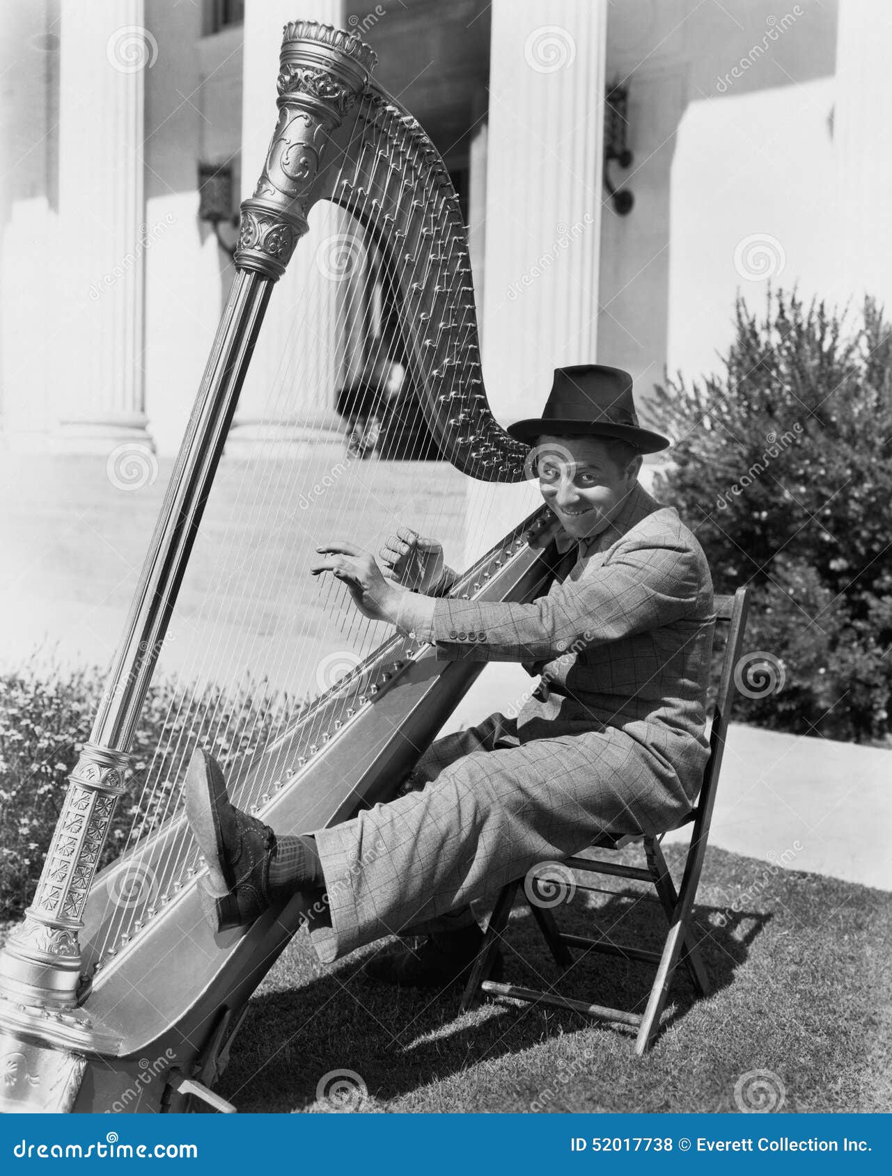 Profile of a Man Playing a Harp and Smiling Stock Photo - Image of ...