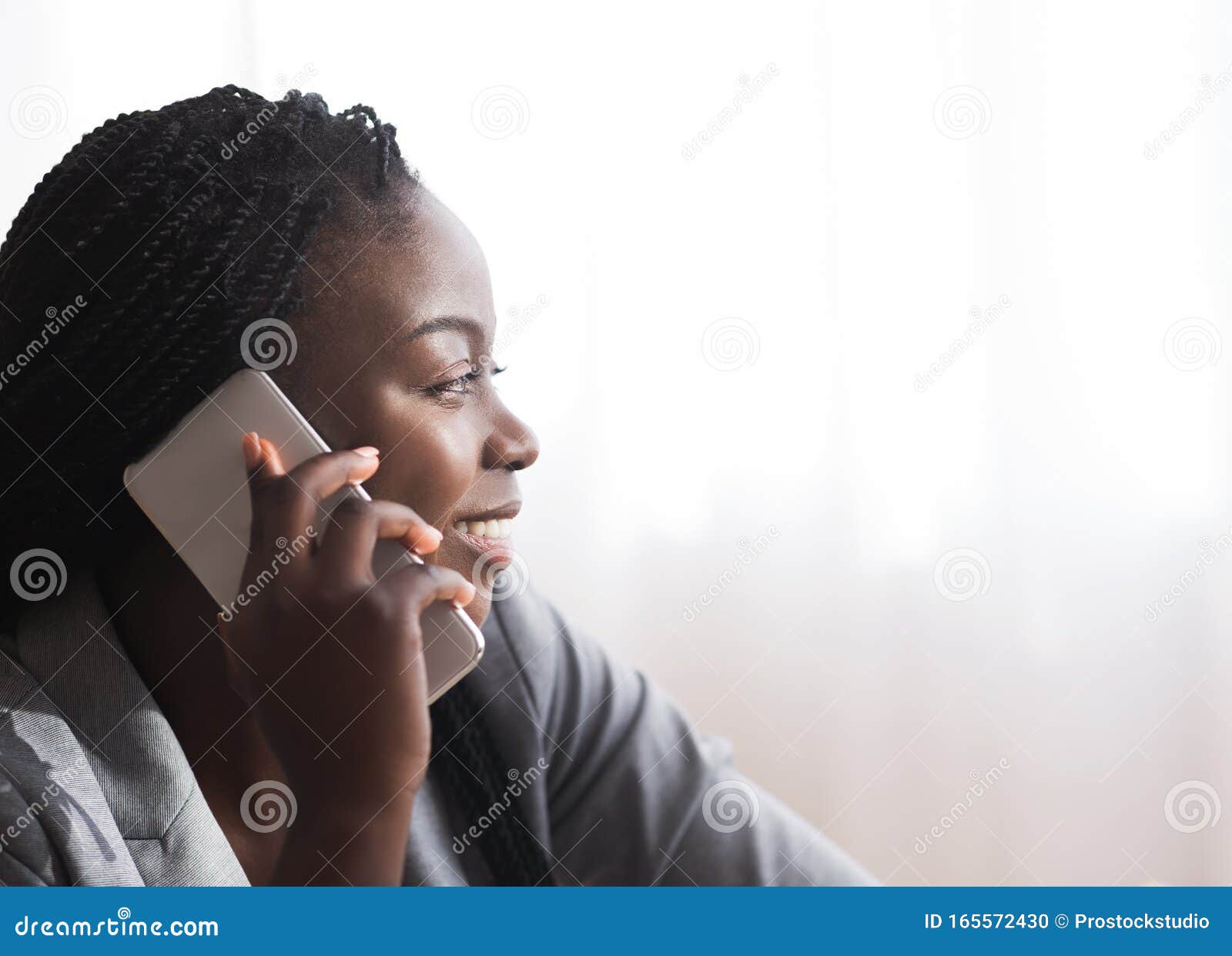 Profile Portrait Of Smilimg African American Woman Talking On Cellphone