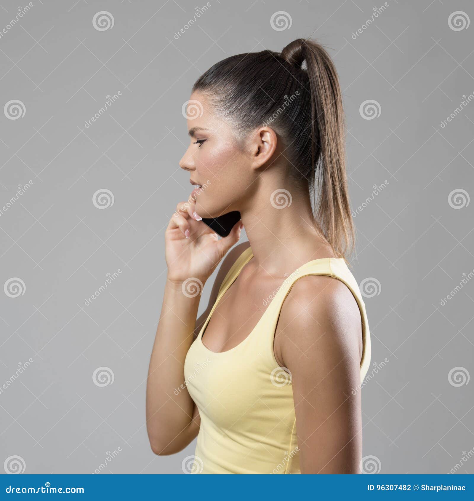 Profile Side View of Fit Woman Talking on the Mobile Phone Looking Down ...