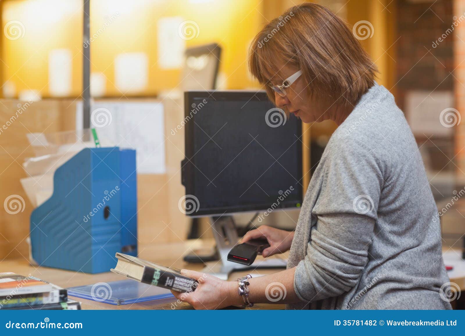 Profile View of Mature Librarian Scanning a Book Stock Photo - Image of ...