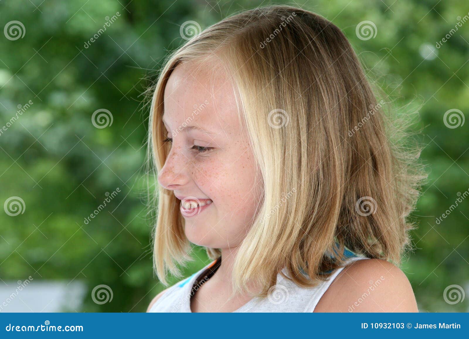 Profile View of a Young Girl Smiling Stock Image - Image of blue ...