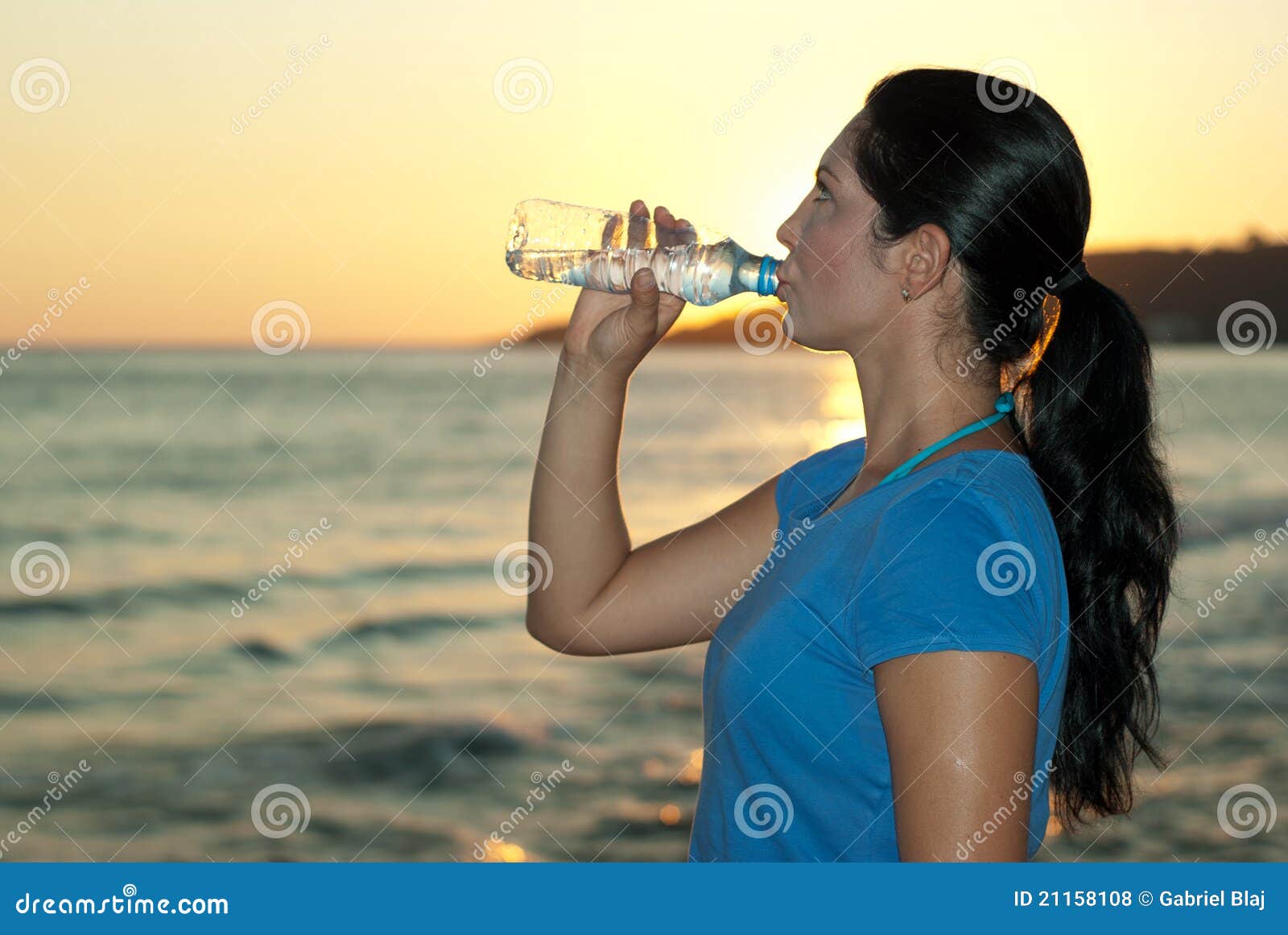 Profile of Woman Drinking Water on the Beach Stock Photo - Image of ...